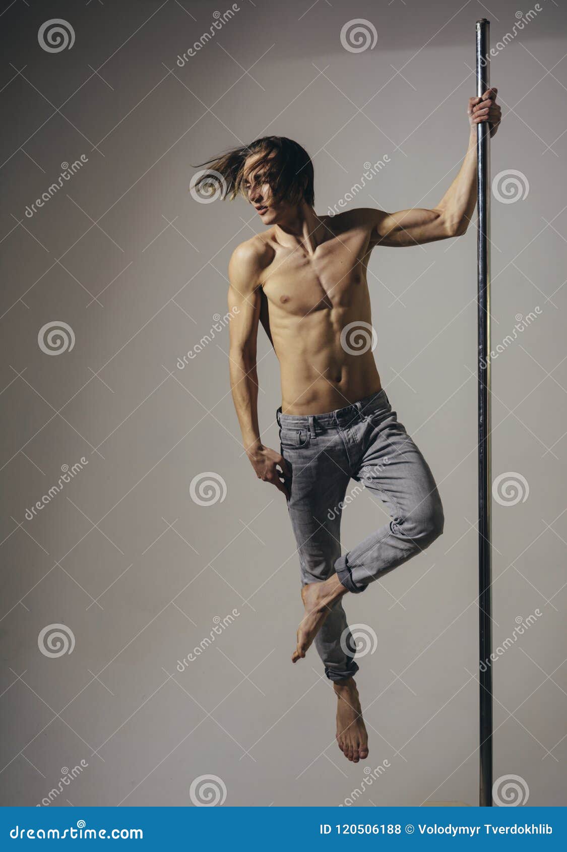 Male Pole Dance Athlete on Pylon in Grey Studio. Stock Photo - Image of ...