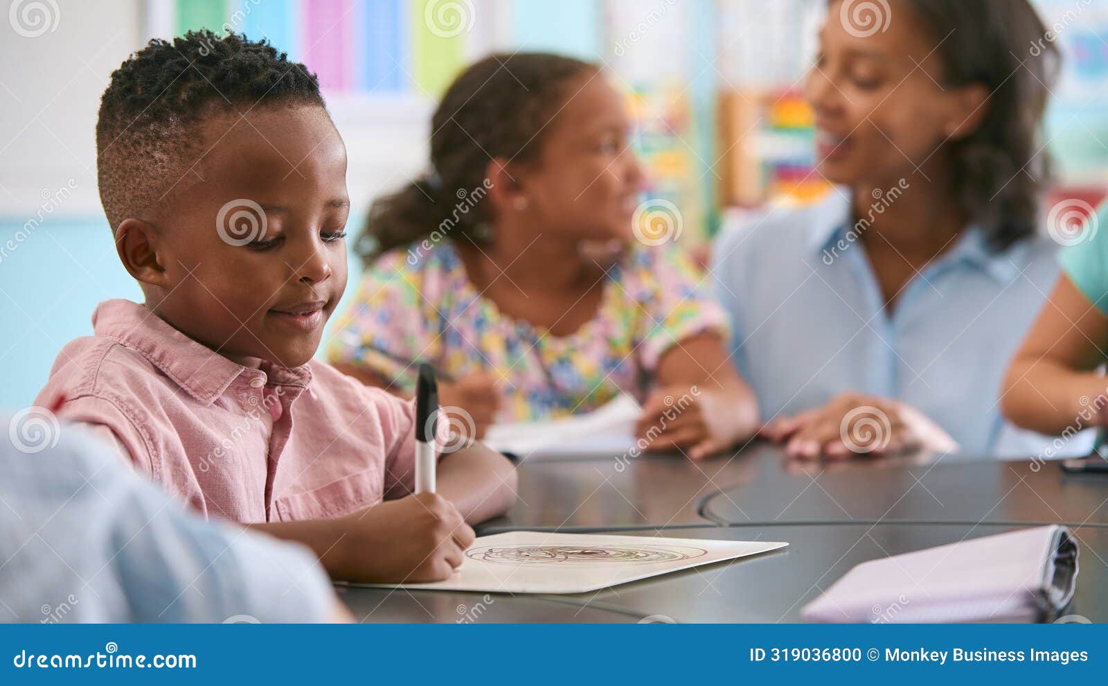 Male Primary or Elementary School Student at Desk in Classroom Stock ...