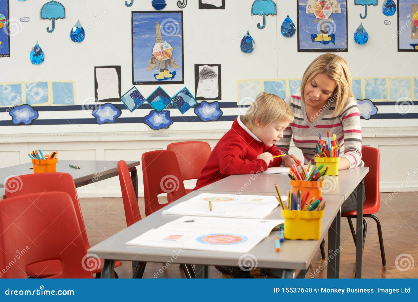 Male Primary School Pupil and Teacher Working Stock Photo - Image of ...