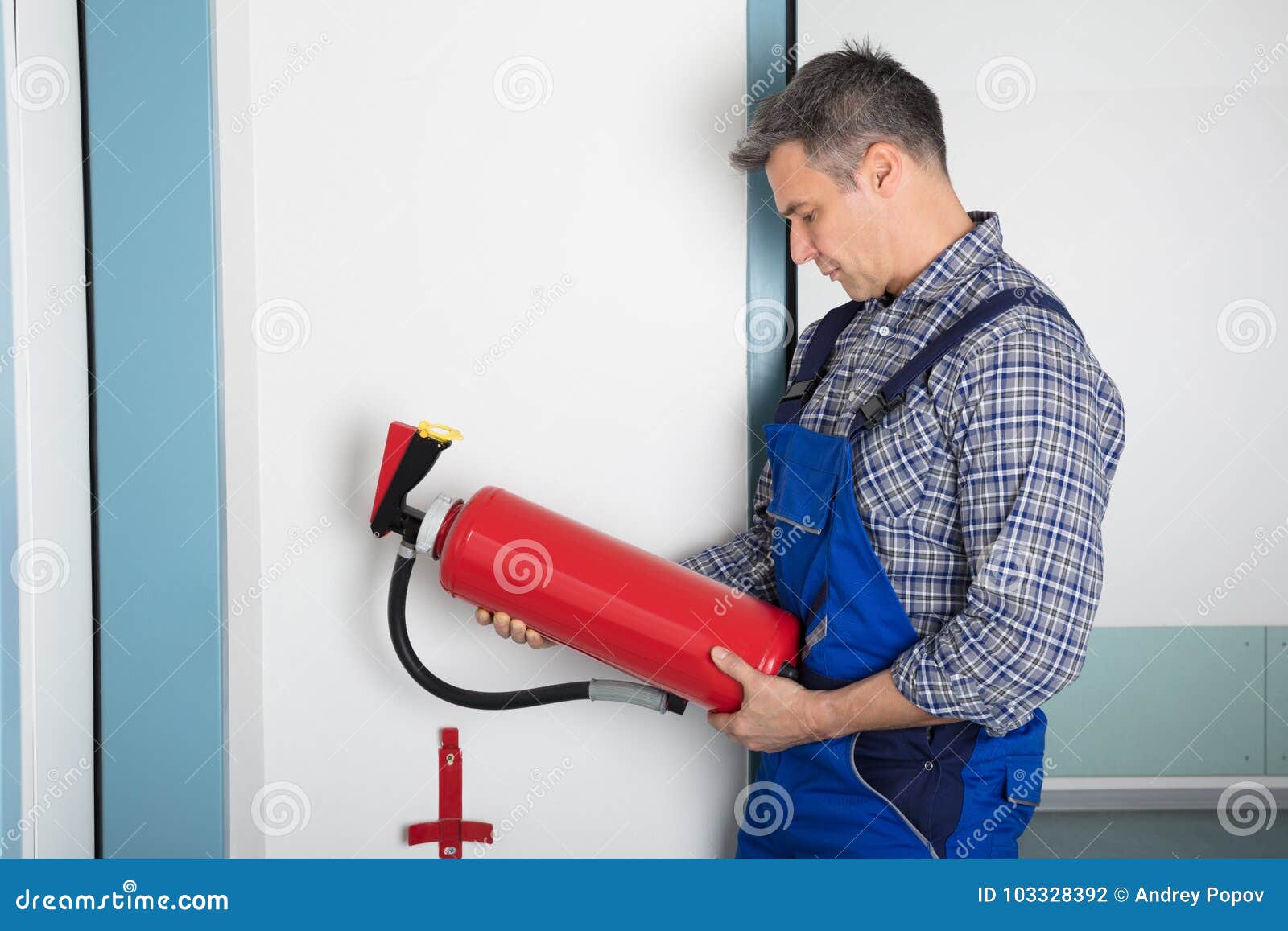 Professional Checking a Fire Extinguisher Stock Photo - Image of check ...