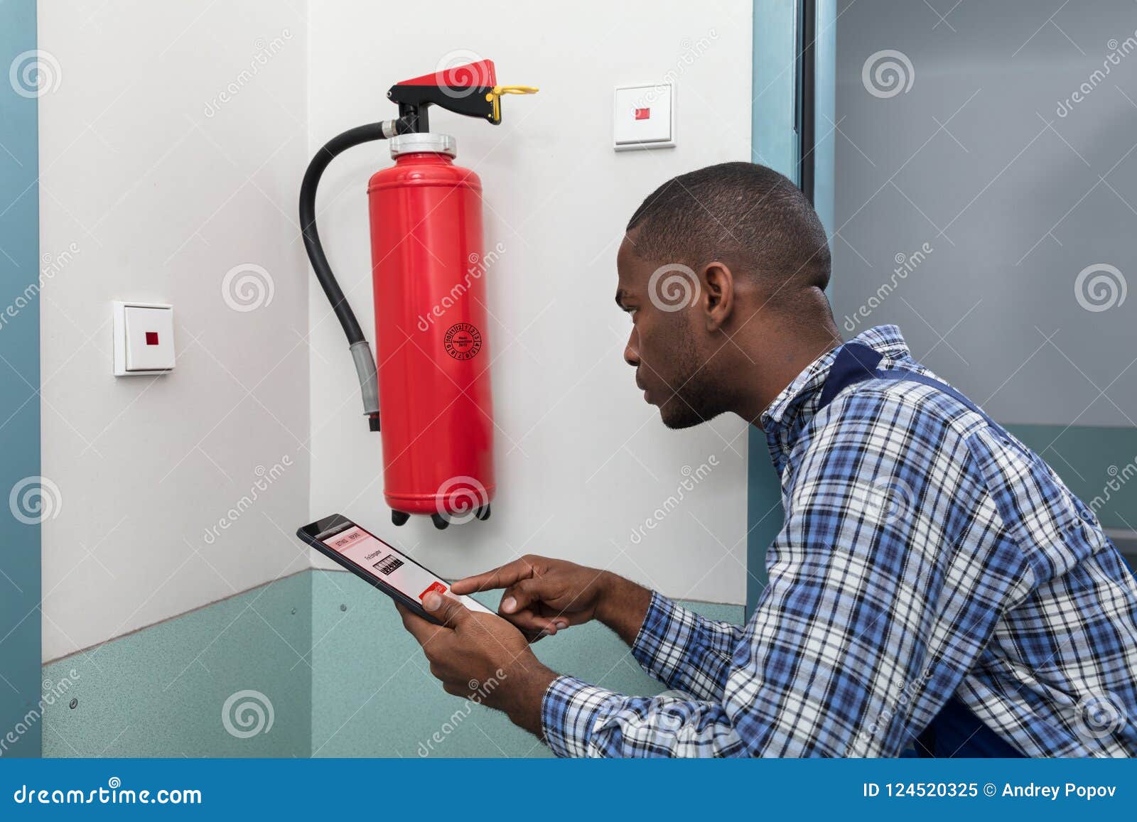 Male Professional Checking a Fire Extinguisher Stock Image - Image of ...