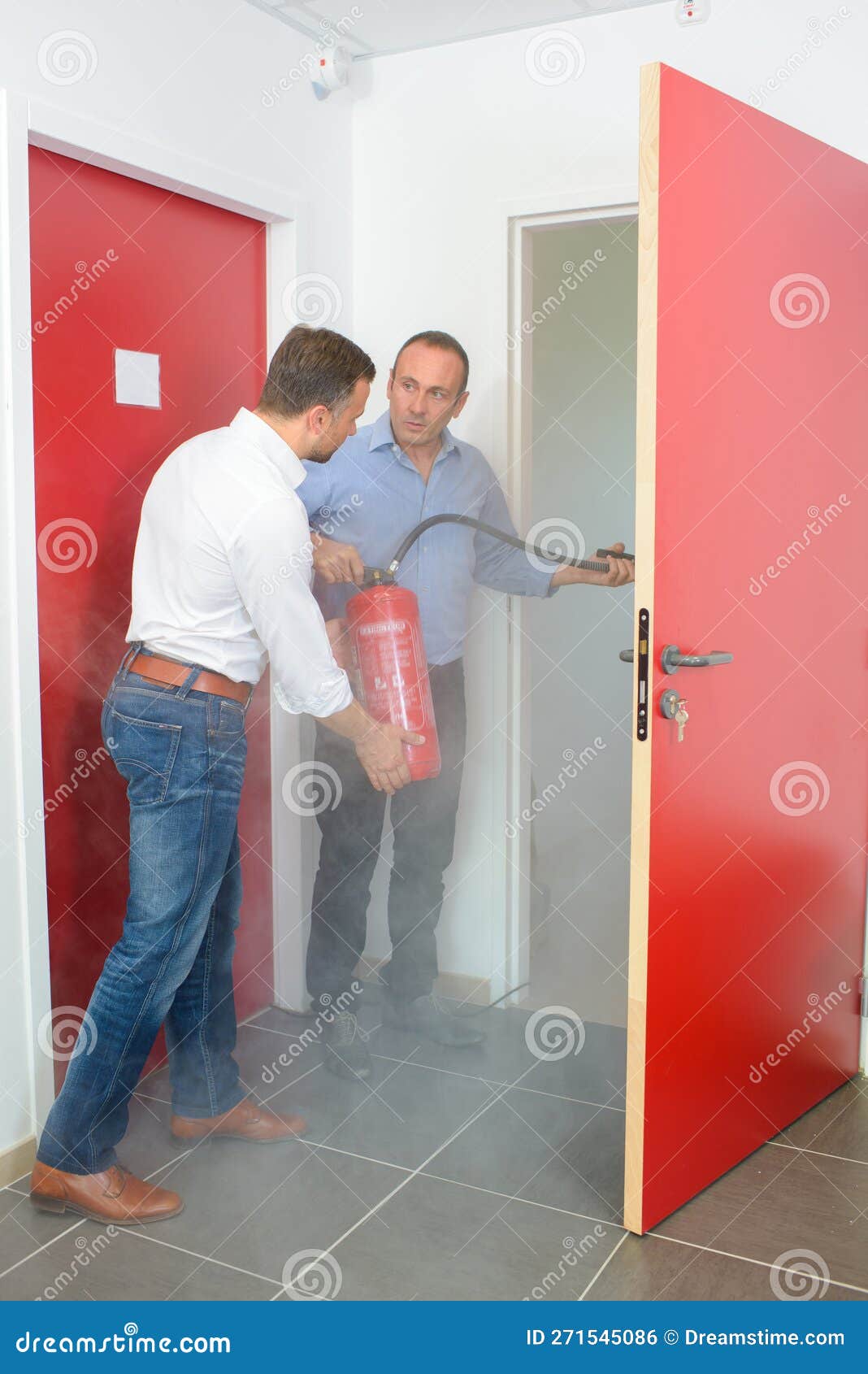 Male Professional Checking Fire Extinguisher Using Clipboard Stock ...