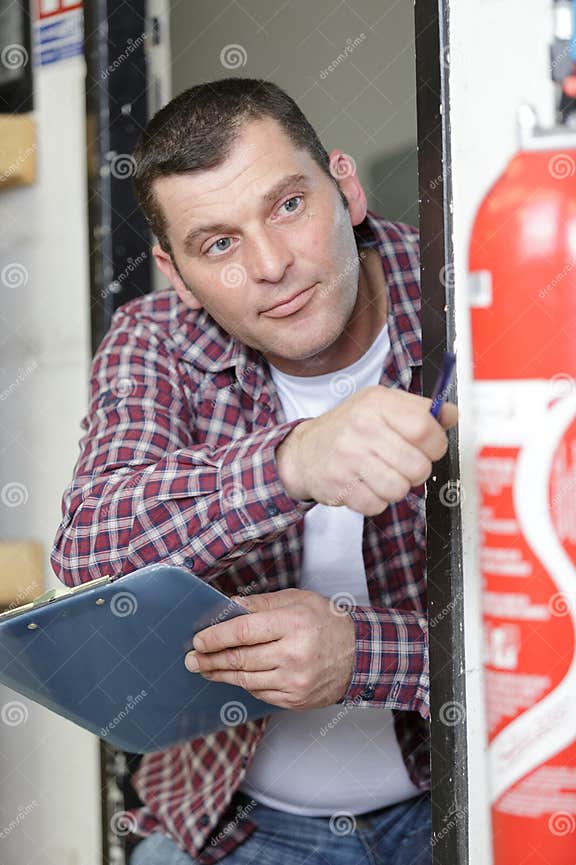 Male Professional Checking Fire Extinguisher Using Clipboard Stock ...