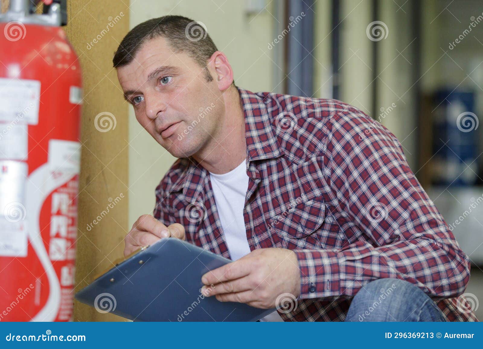 Male Professional Checking Fire Extinguisher Using Clipboard Stock ...