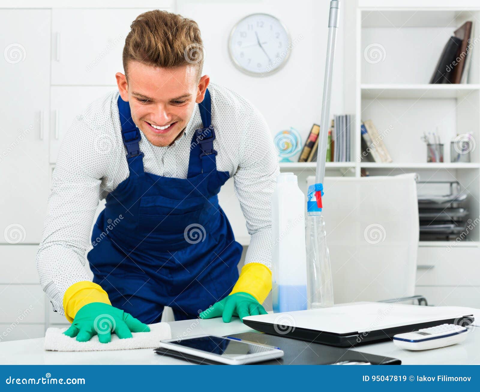 Male Professional Janitor Dusting in Office Stock Image - Image of ...