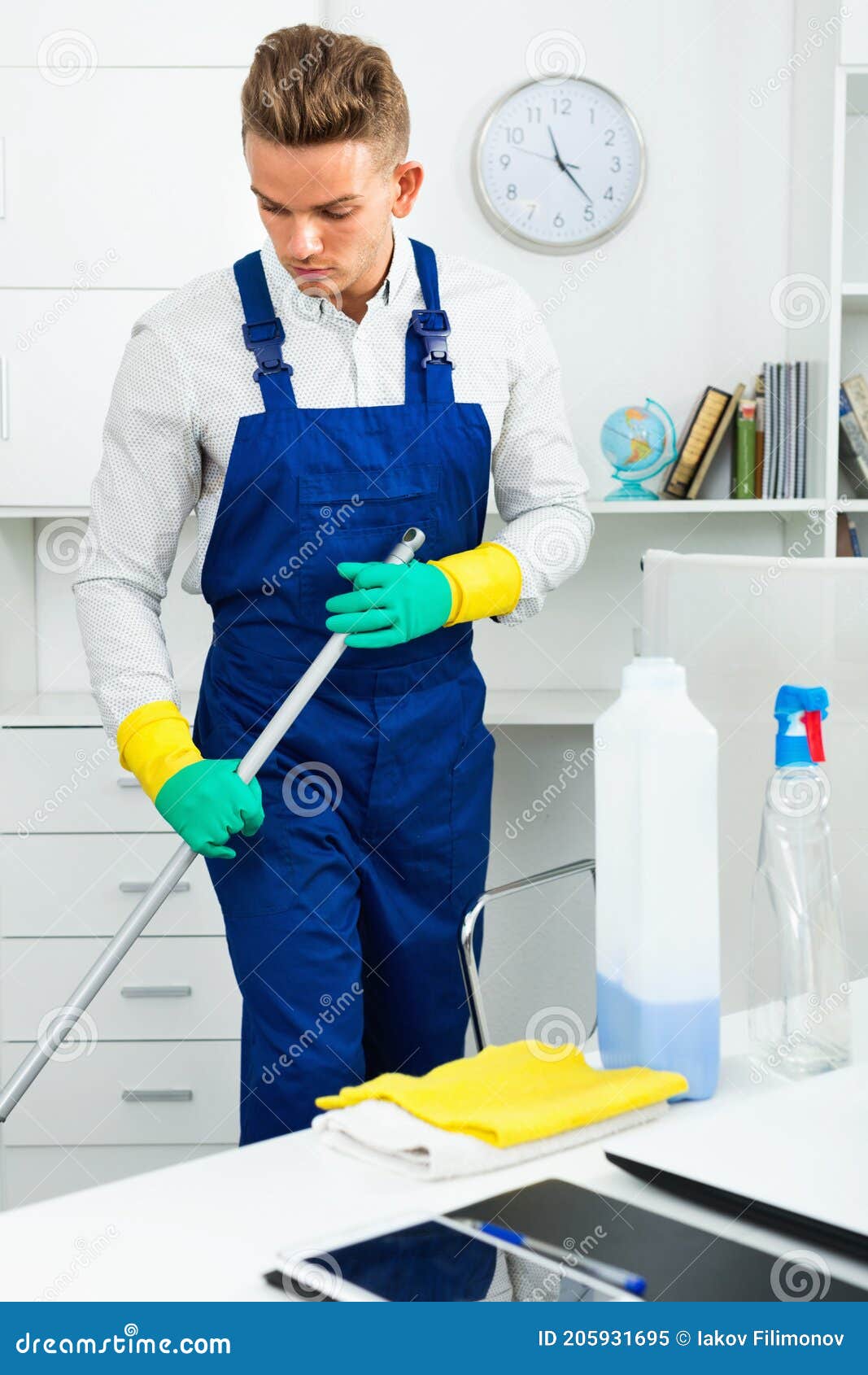 Male Professional Janitor Dusting in Office Stock Image - Image of ...