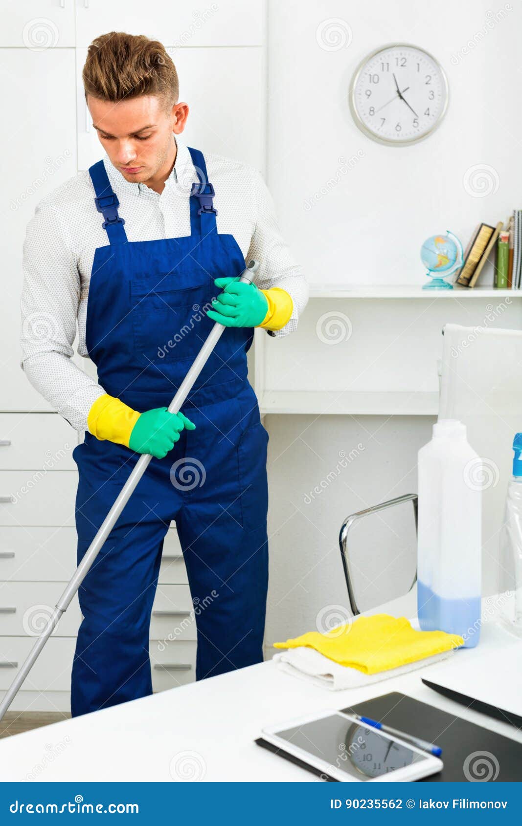 Male Professional Janitor Dusting in Office Stock Photo - Image of ...