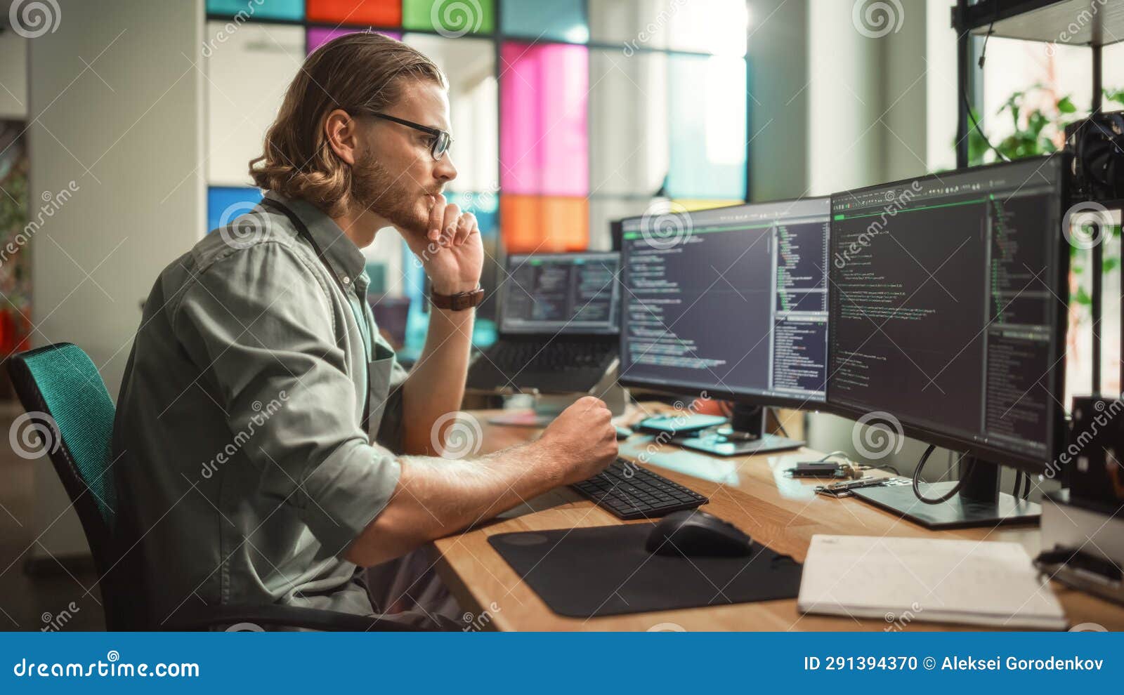 Male Programmer Coding On Desktop Computer With Two Monitors Set Up In 6867