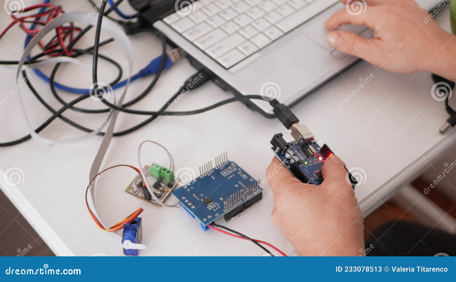 Male Programmer Creates Robotics, an Arduino Board Controls Servo ...