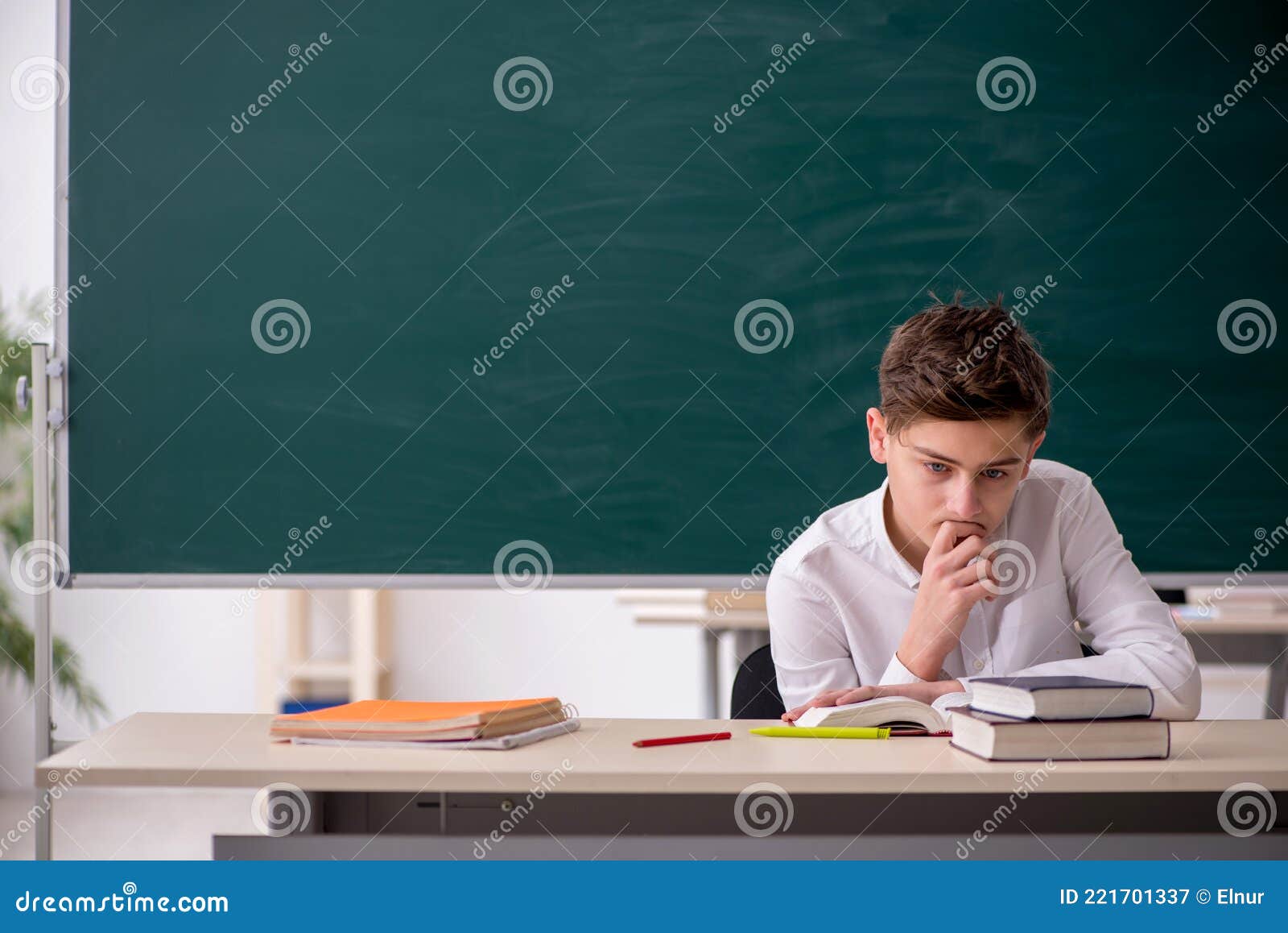 Boy Sitting in the Classrom Stock Image - Image of college, blackboard ...