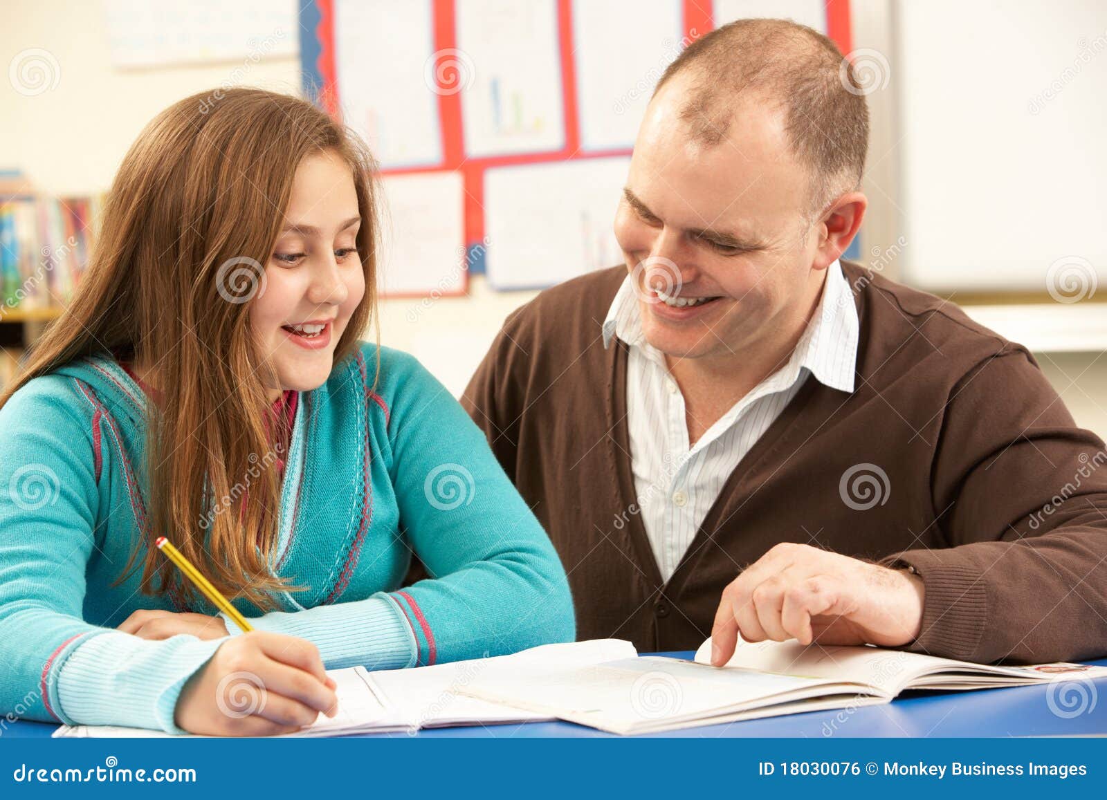 Male Pupil Studying in Classroom with Teacher Stock Photo - Image of ...