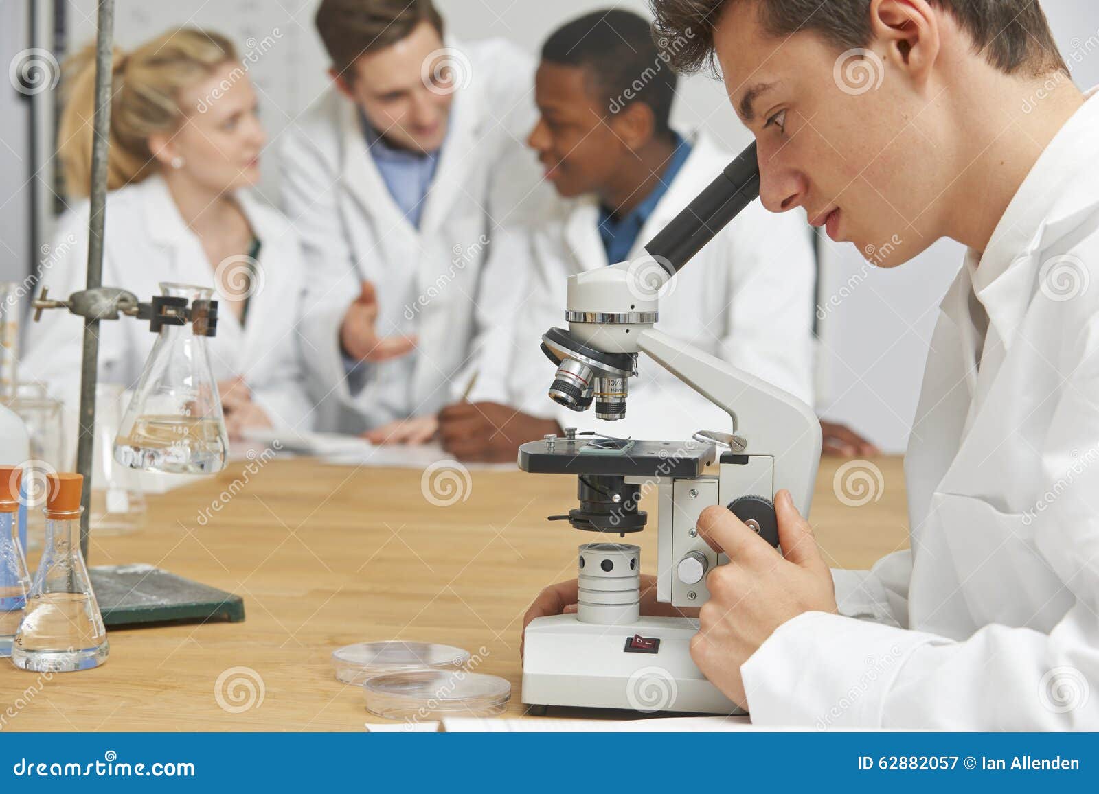 Male Pupil Using Microscope in Science Class Stock Image - Image of ...