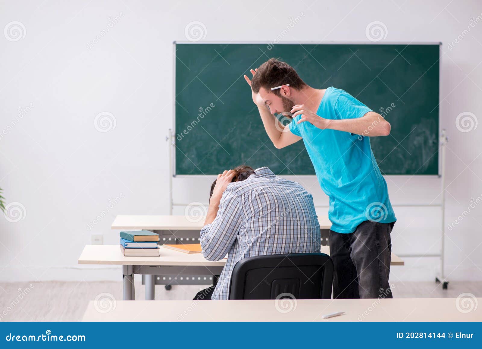 Two Male Pupils in Bullying Concept in the Classroom Stock Photo ...