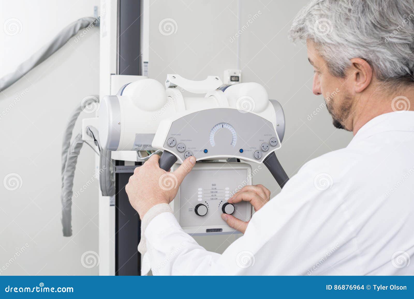 Male Radiologist Adjusting the Controls on X-ray Machine Stock Photo ...