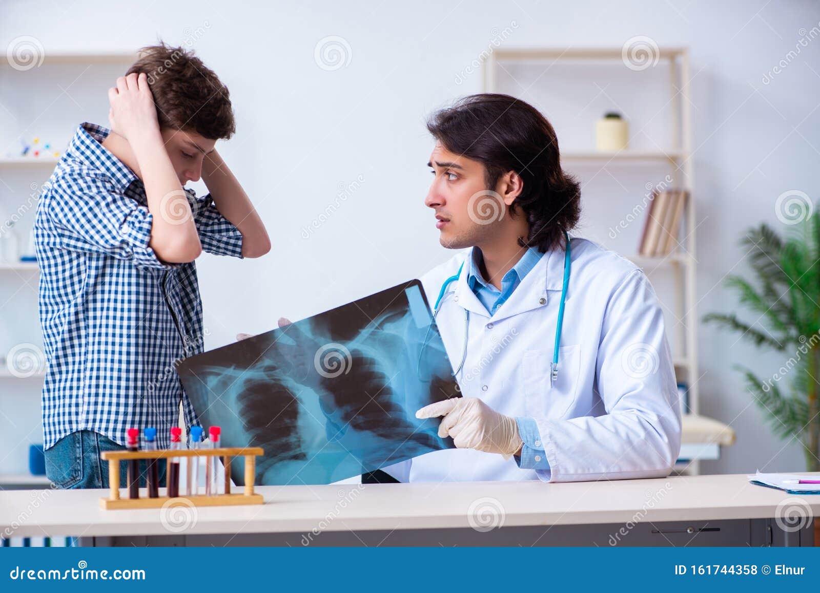 Male Radiologist Looking at Boy`s Images Stock Photo - Image of ...