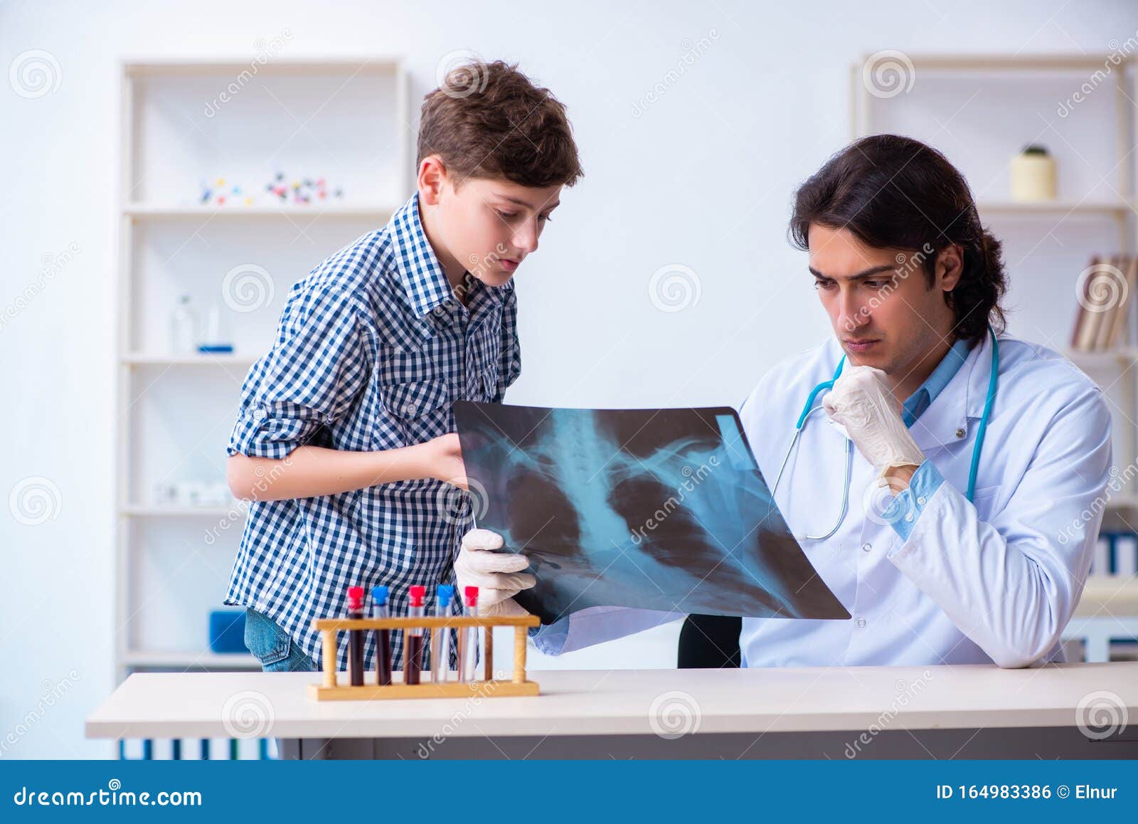 Male Radiologist Looking at Boy`s Images Stock Photo - Image of ...