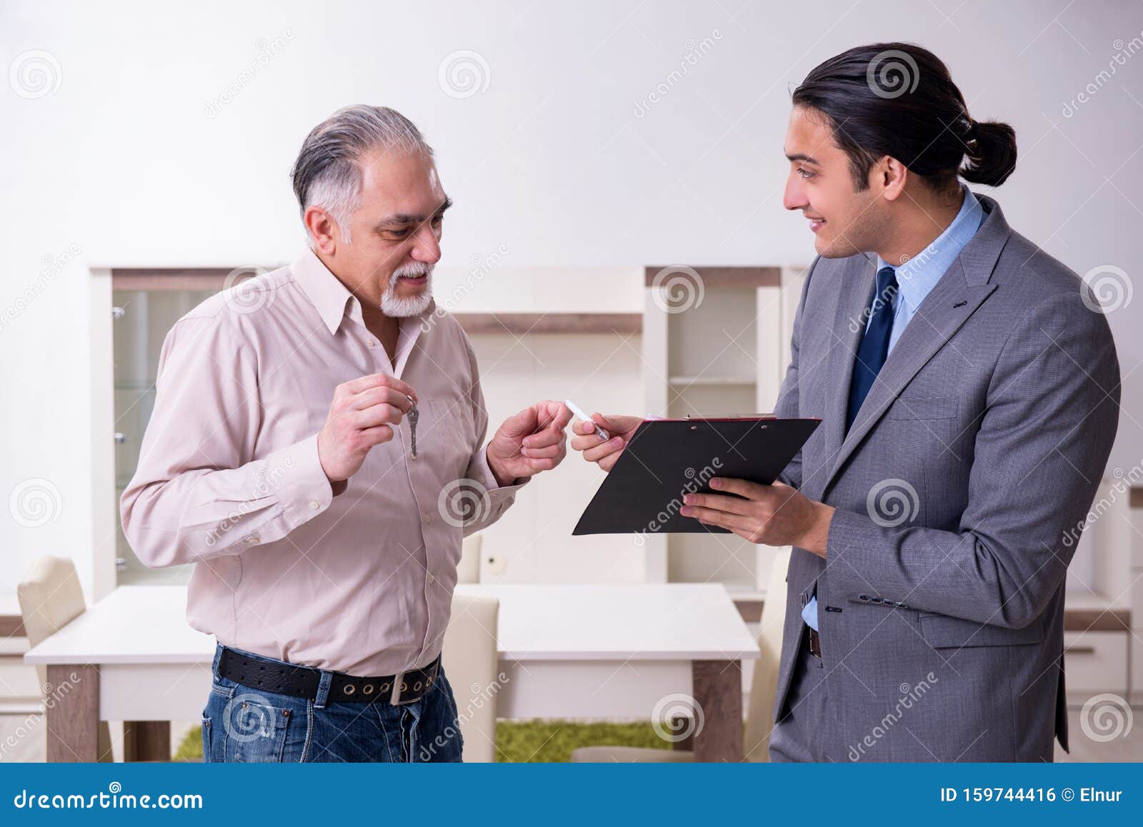 Male Real Estate Agent and Male Client in the Apartment Stock Photo ...