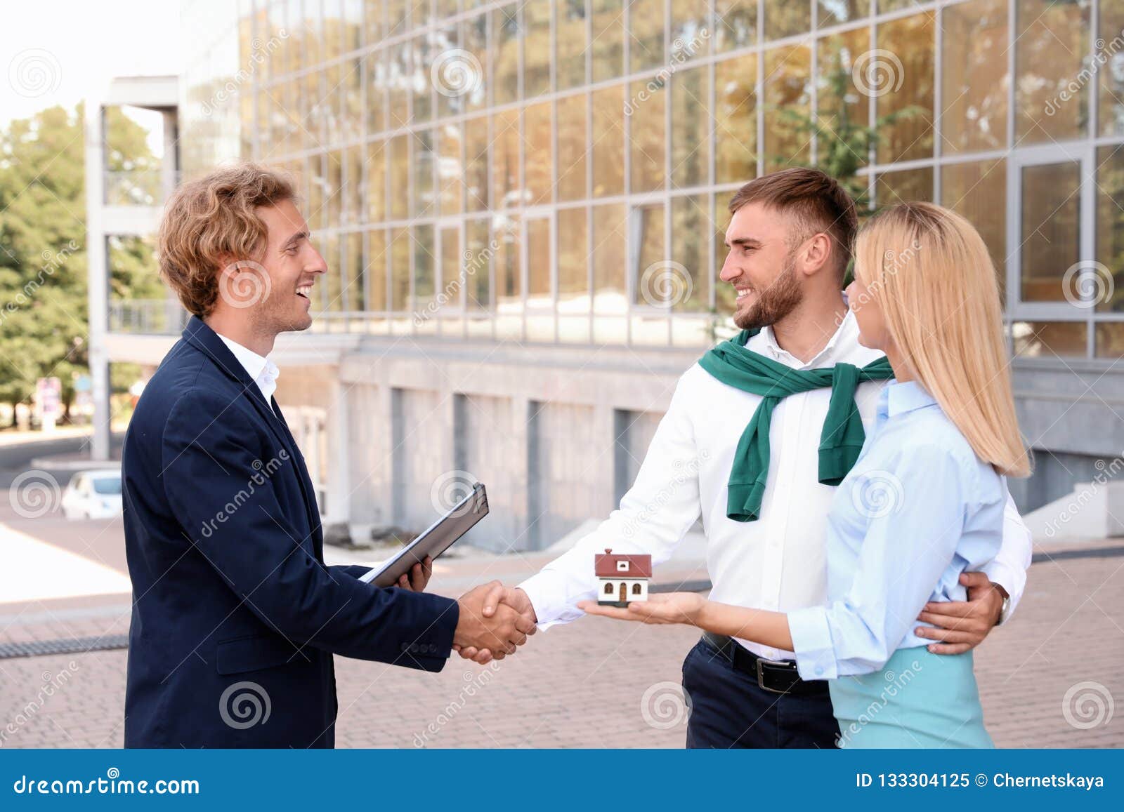 Male Real Estate Agent Shaking Hands with Clients Stock Image - Image ...