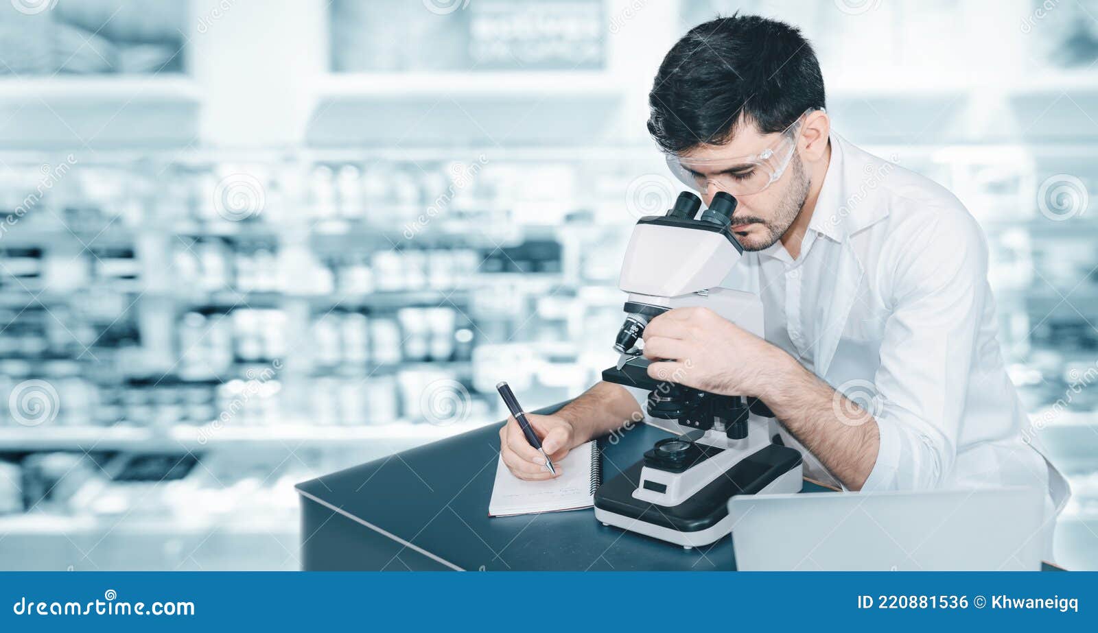 Male Research Medical Scientist Working with Microscope Testing ...