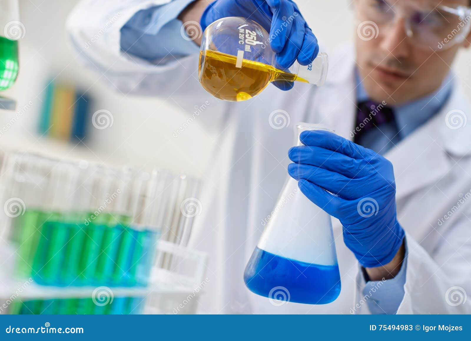 Male Researcher Examining Flasks with Different Samples Stock Image ...
