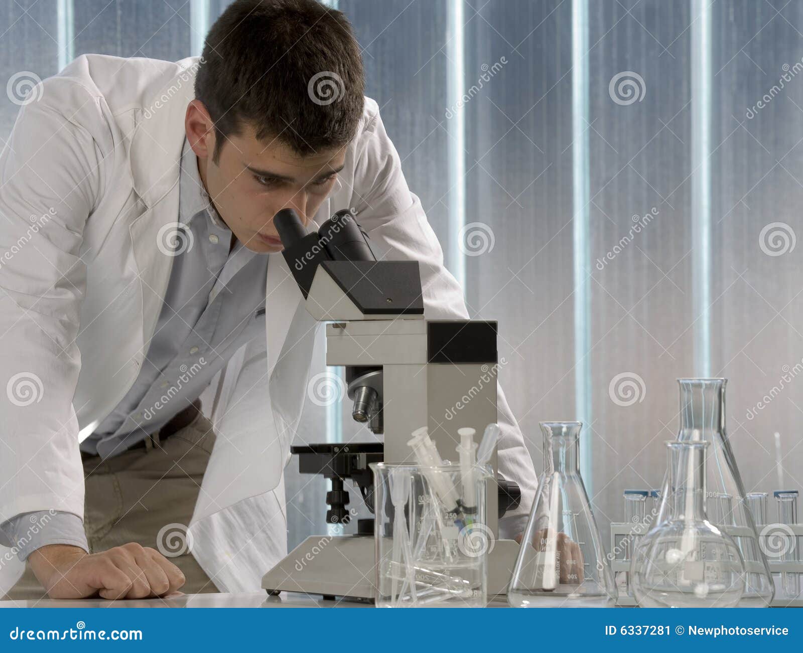 Male Researcher Looking through a Microscope in a Stock Image - Image ...