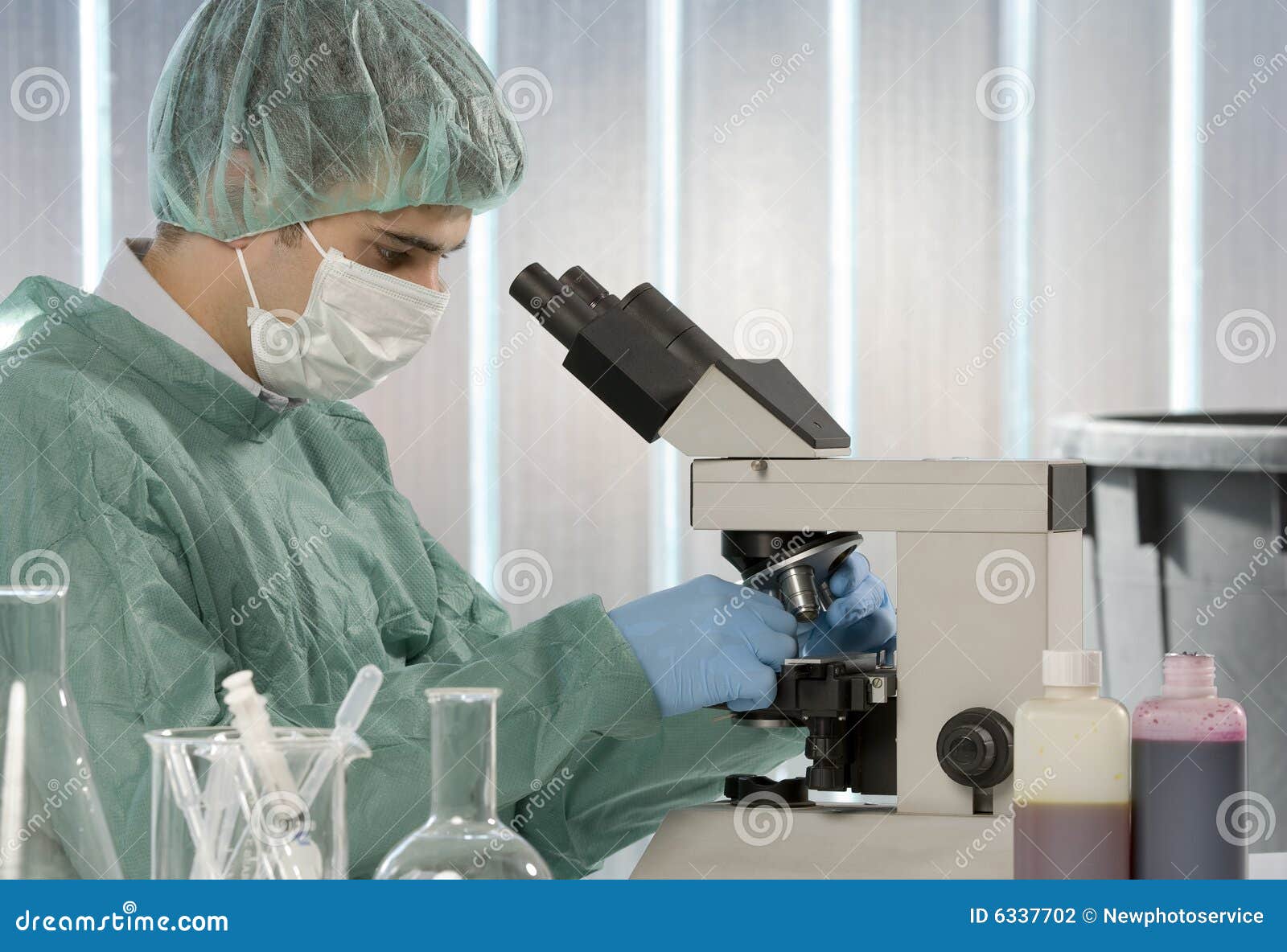 Male Researcher Looking through a Microscope in a Stock Photo - Image ...