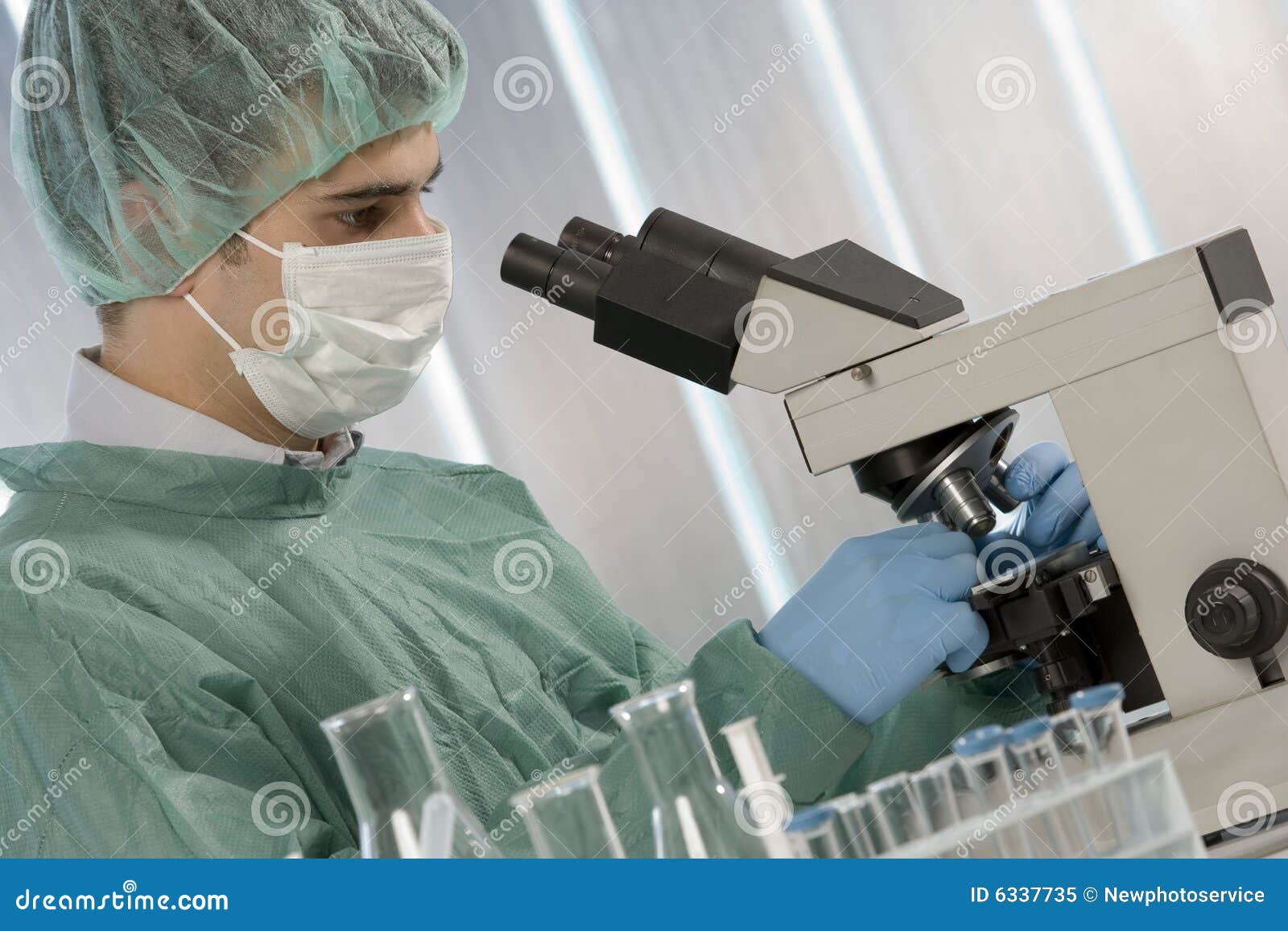 Male Researcher Looking through a Microscope in a Stock Image - Image ...