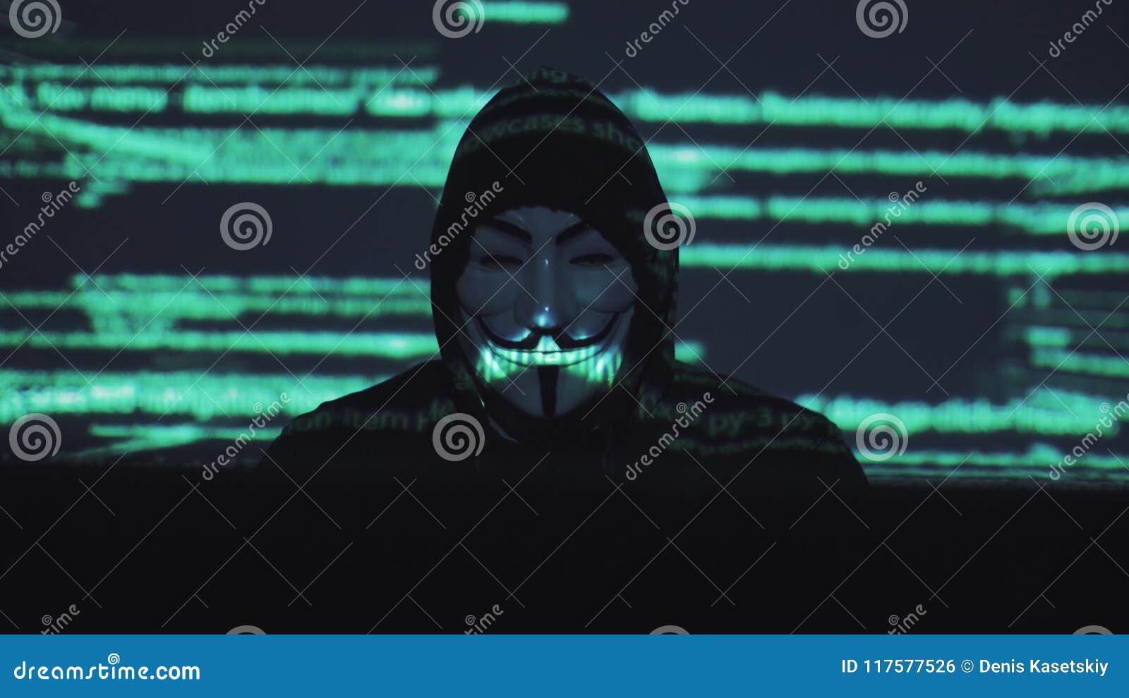 A Male Robber in a Mask Works on a Computer in a Dark Room. Computer ...