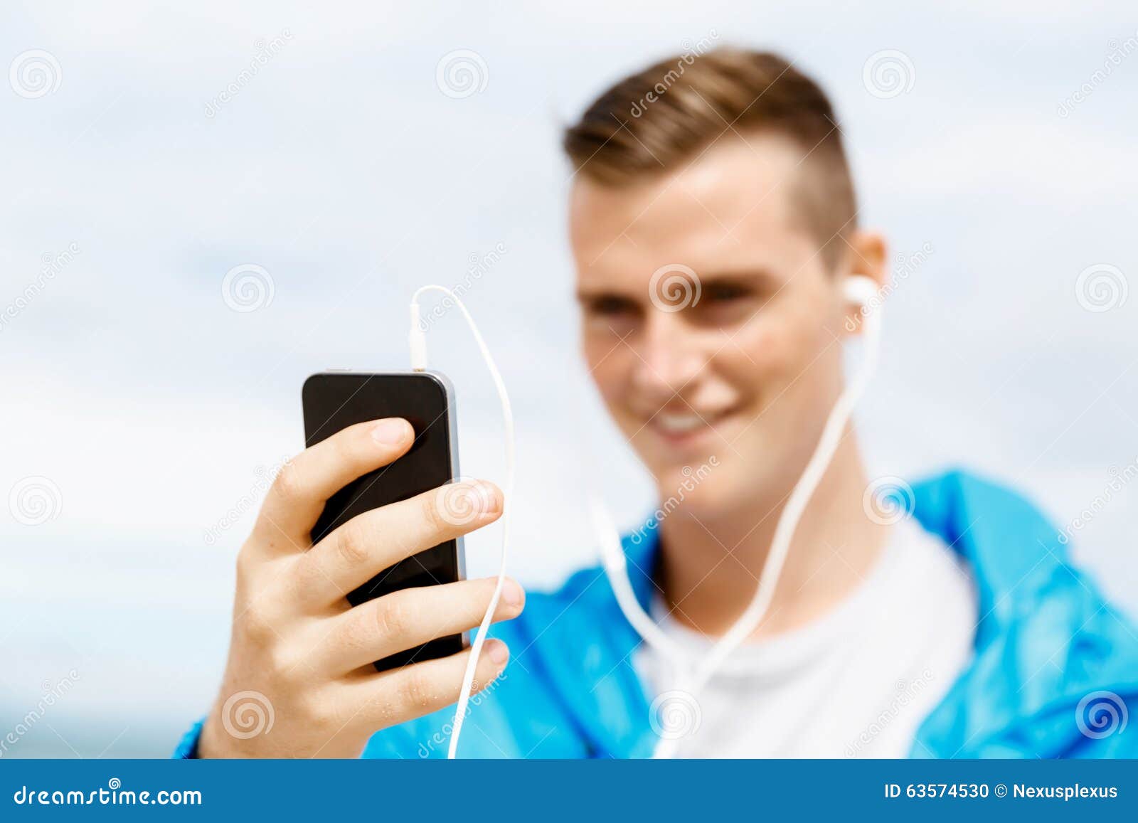 Male Runner with His Mobile Smart Phone Standing Stock Photo - Image of ...