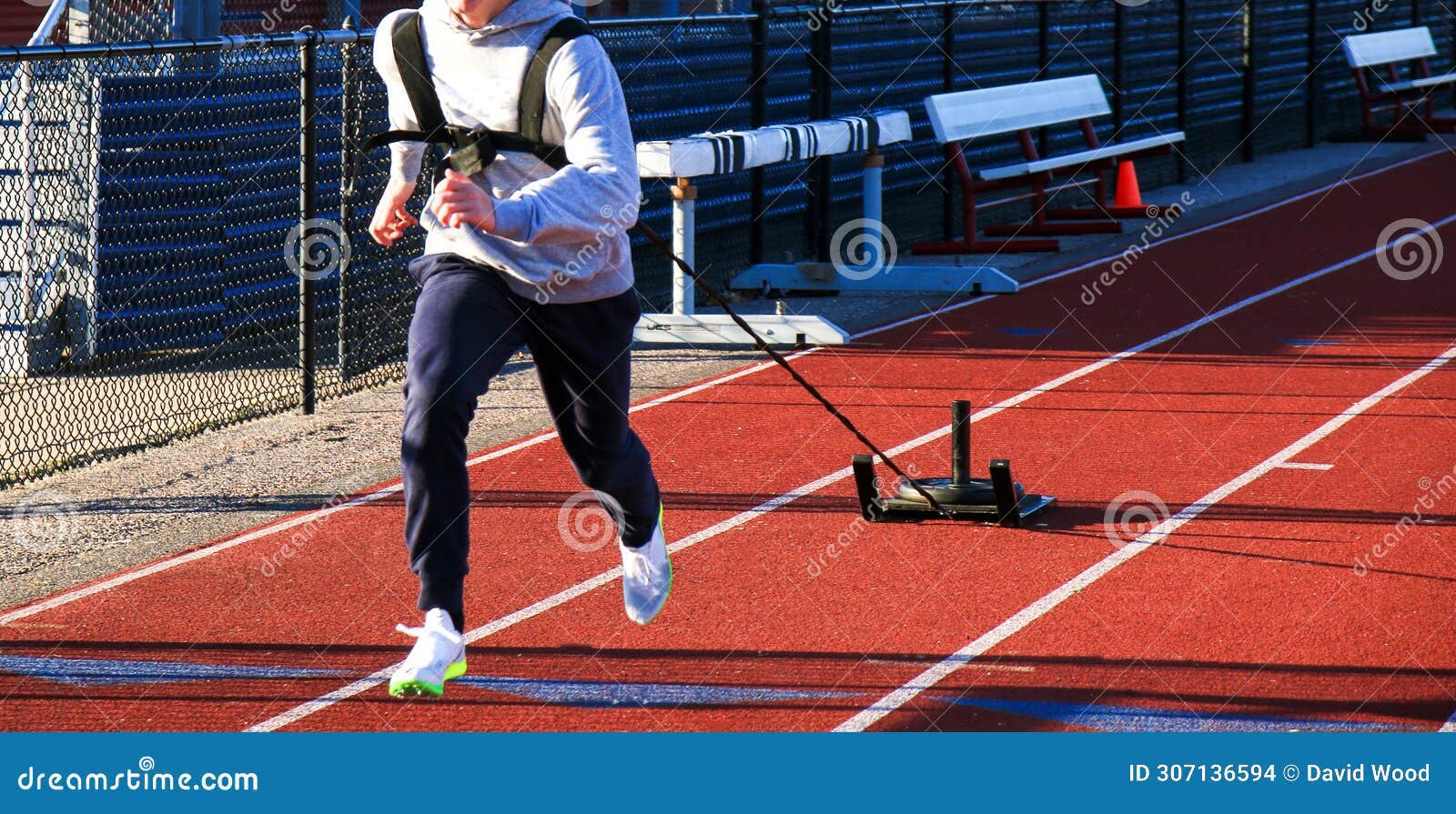 Male Runner Pulling a Sled with Weight on a Track Stock Photo - Image ...
