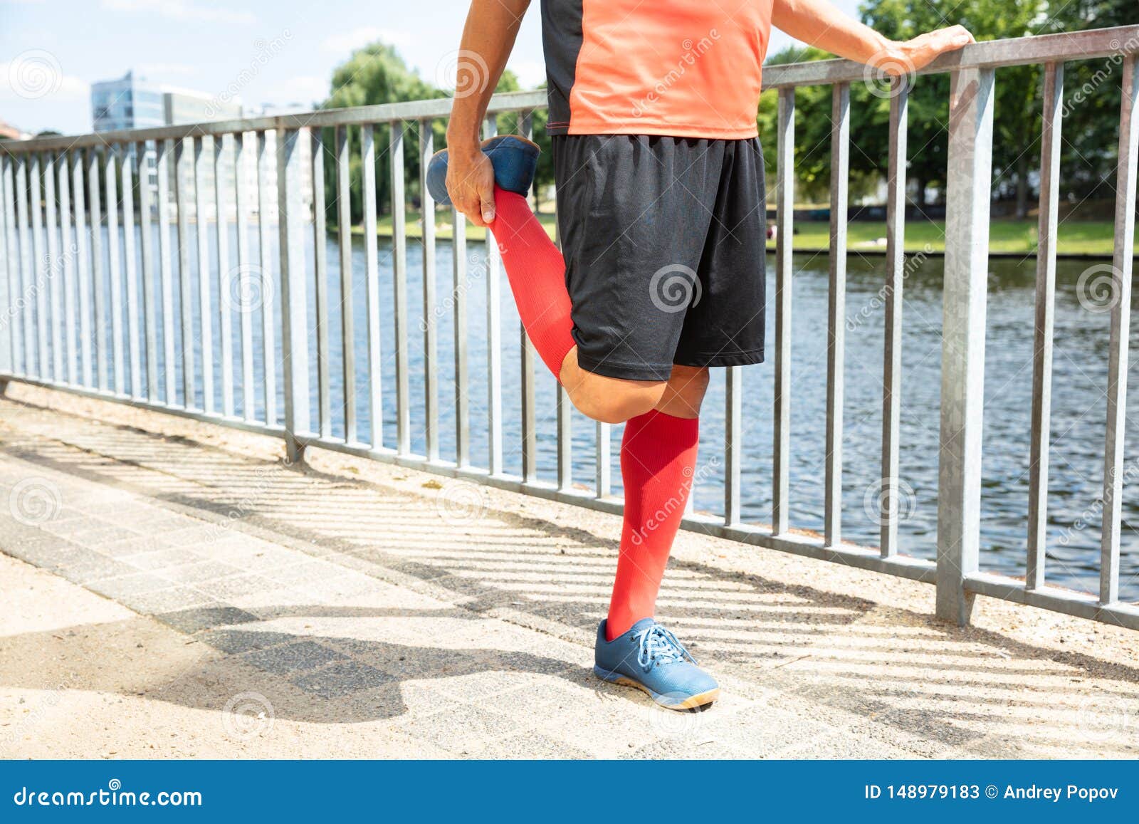 Male Runner Stretching His Leg Stock Image - Image of park, closeup ...