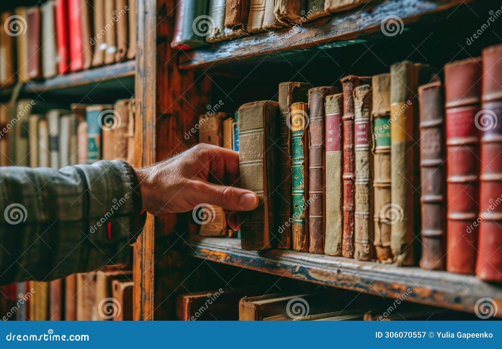 Male& X27;s Hand Selecting a Book from the Shelf of Books Stock Image ...