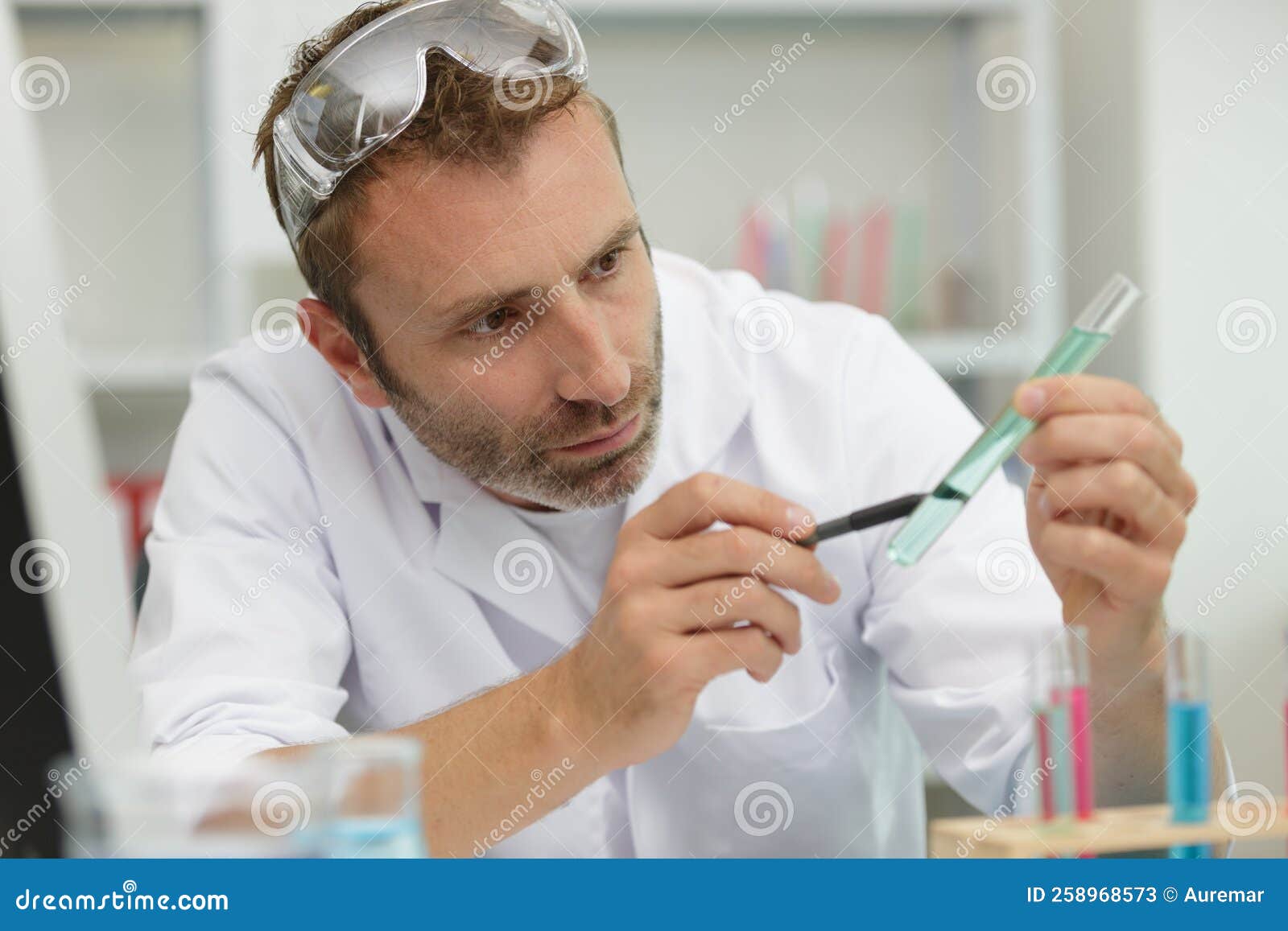 Male Scientist Analysing Liquid in Test Tube Stock Image - Image of ...