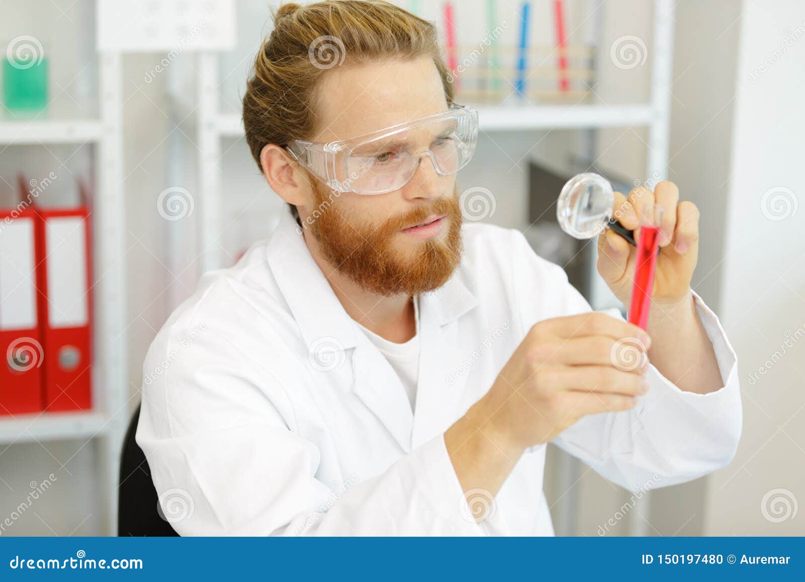 Male Scientist Analysing Something through Magnifying Glass Stock Photo ...