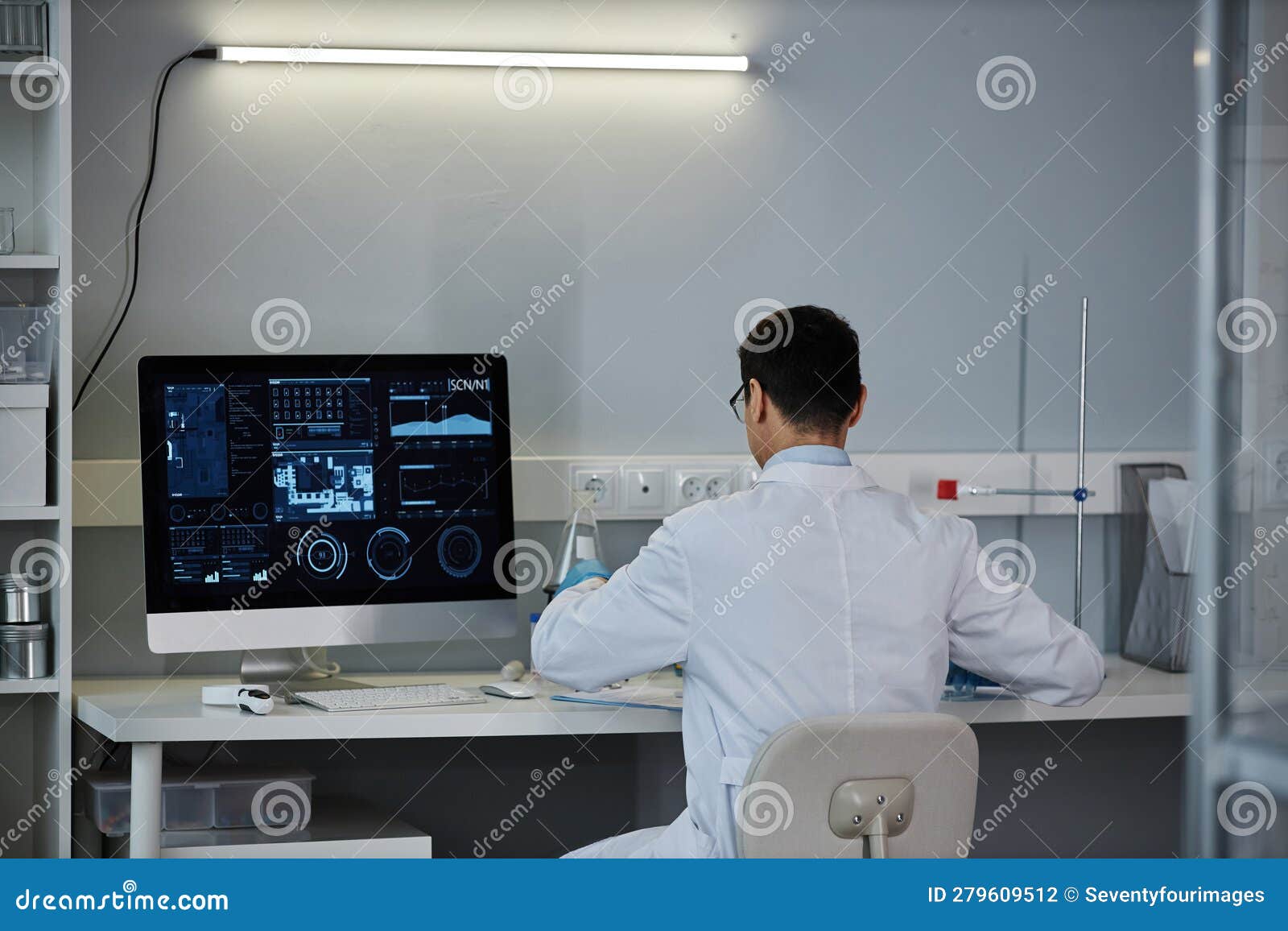 Male Scientist at Desk in Laboratory with Data on Computer Screen Stock ...