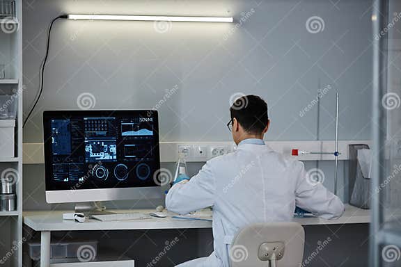 Male Scientist at Desk in Laboratory with Data on Computer Screen Stock ...
