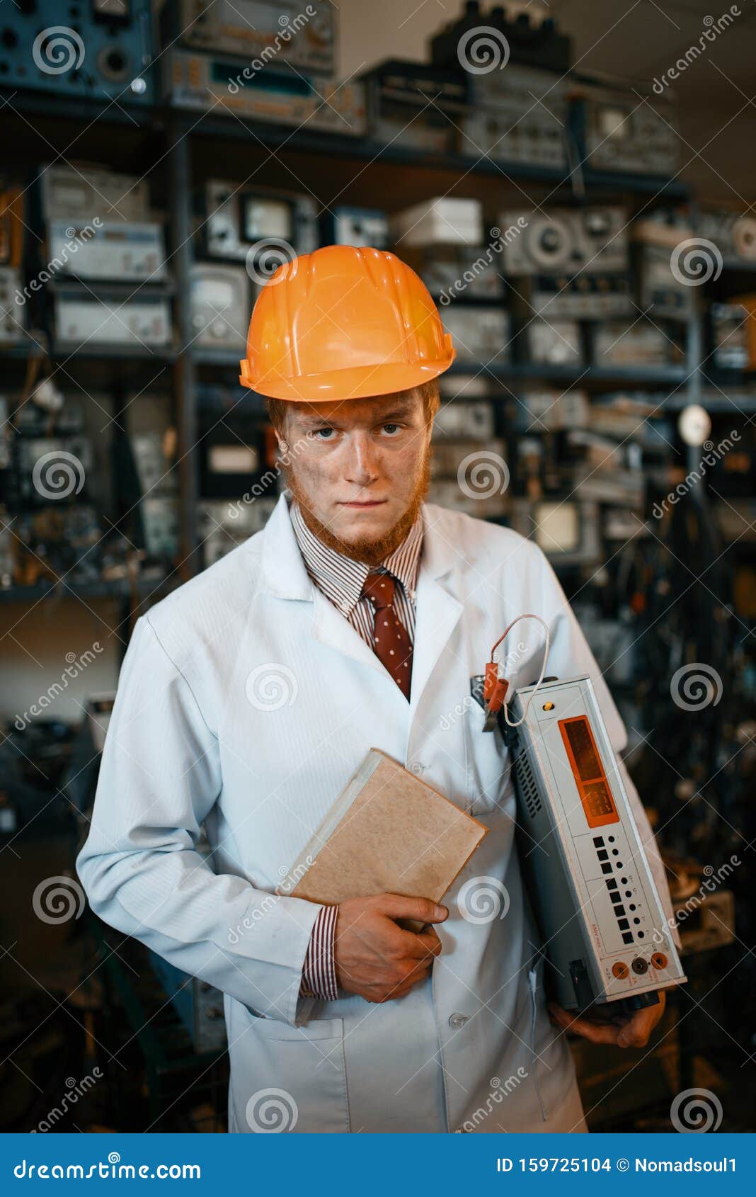 Male Scientist in Helmet Holding a Book and Device Stock Photo - Image ...