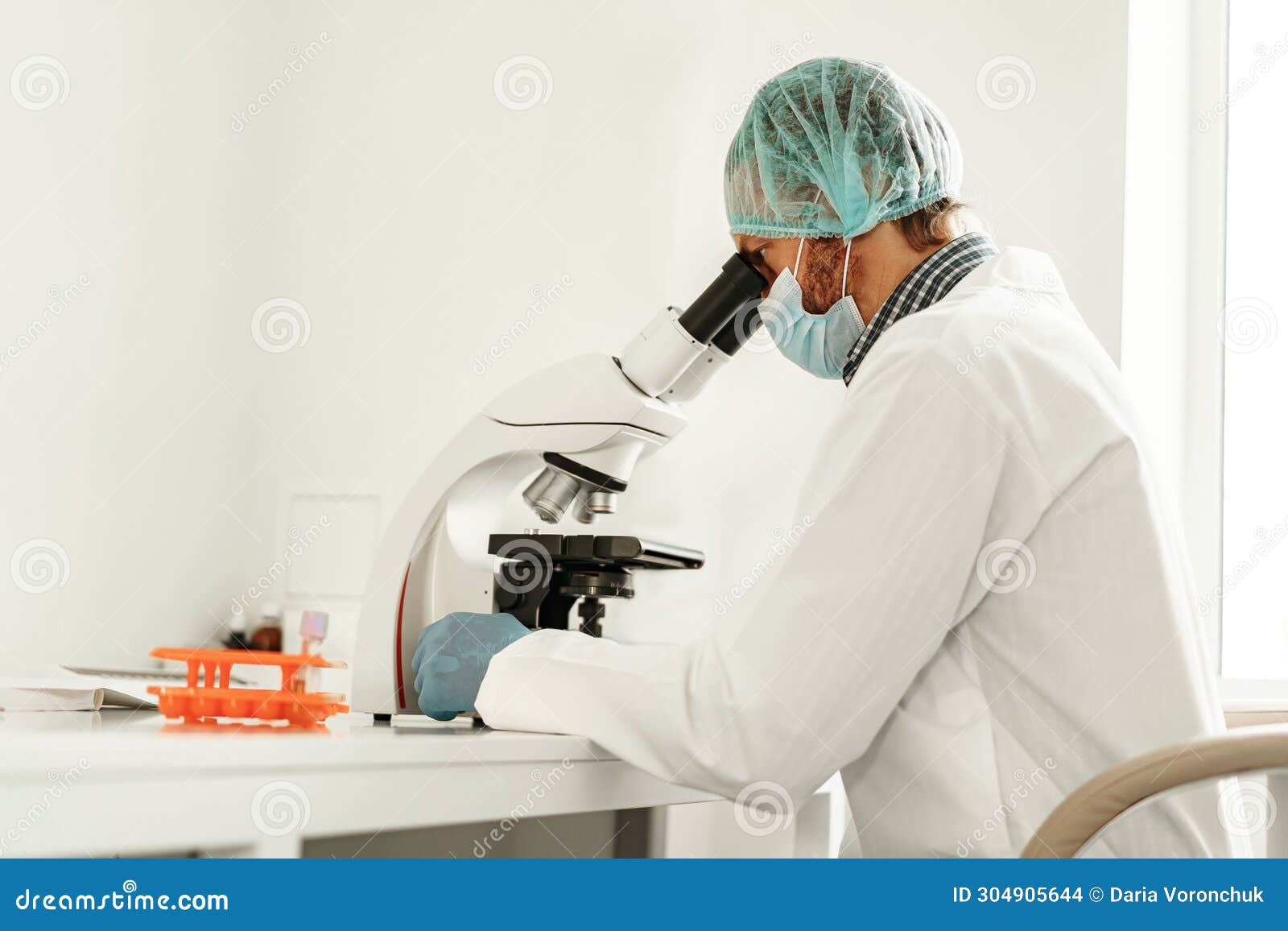 Male Scientist Looking Under Microscope Does Analysis of Test Sample in ...
