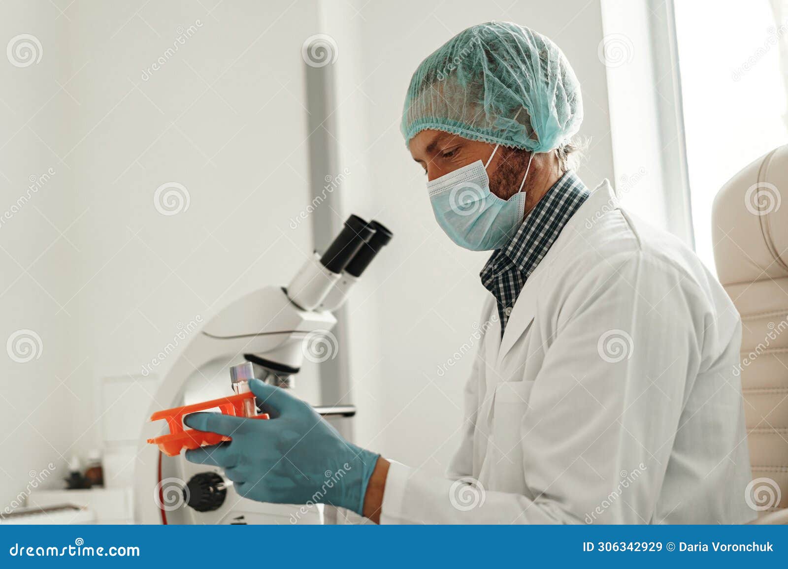 Biochemical Research Scientist Working with Microscope in ...