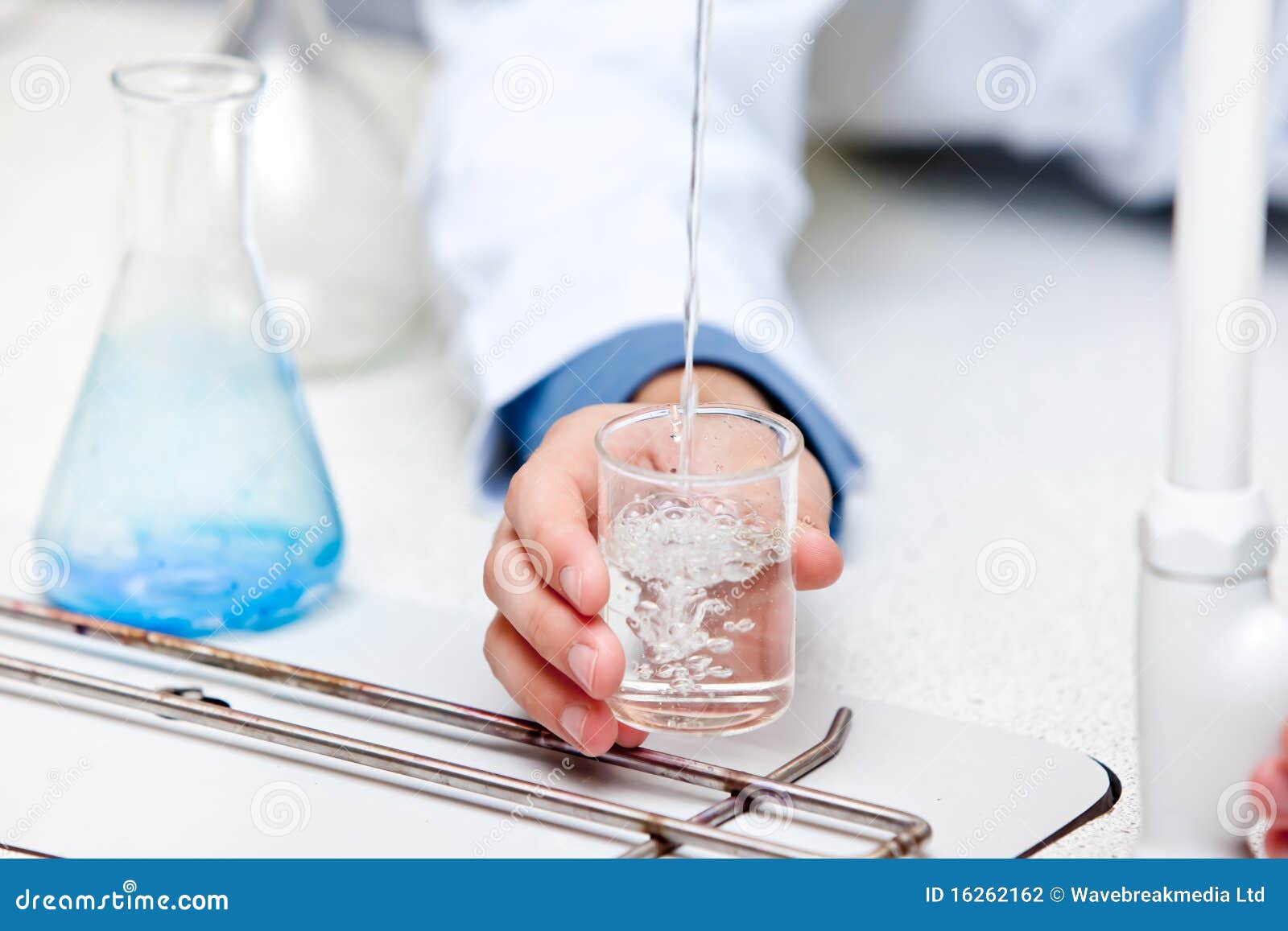 Male Scientist Pouring Liquid into a Becher Stock Photo - Image of ...