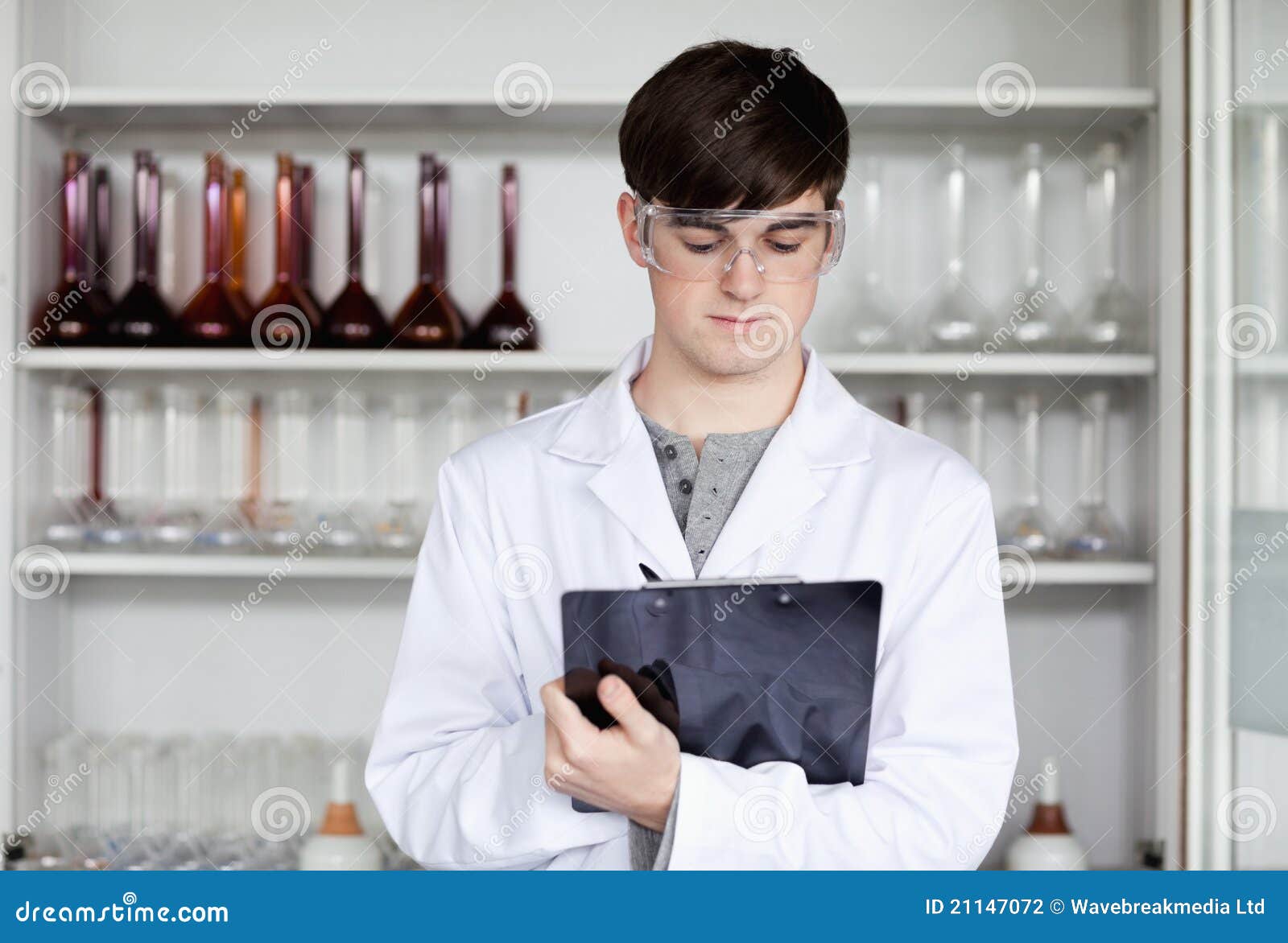 Male Scientist Writing on a Clipboard Stock Photo - Image of ...