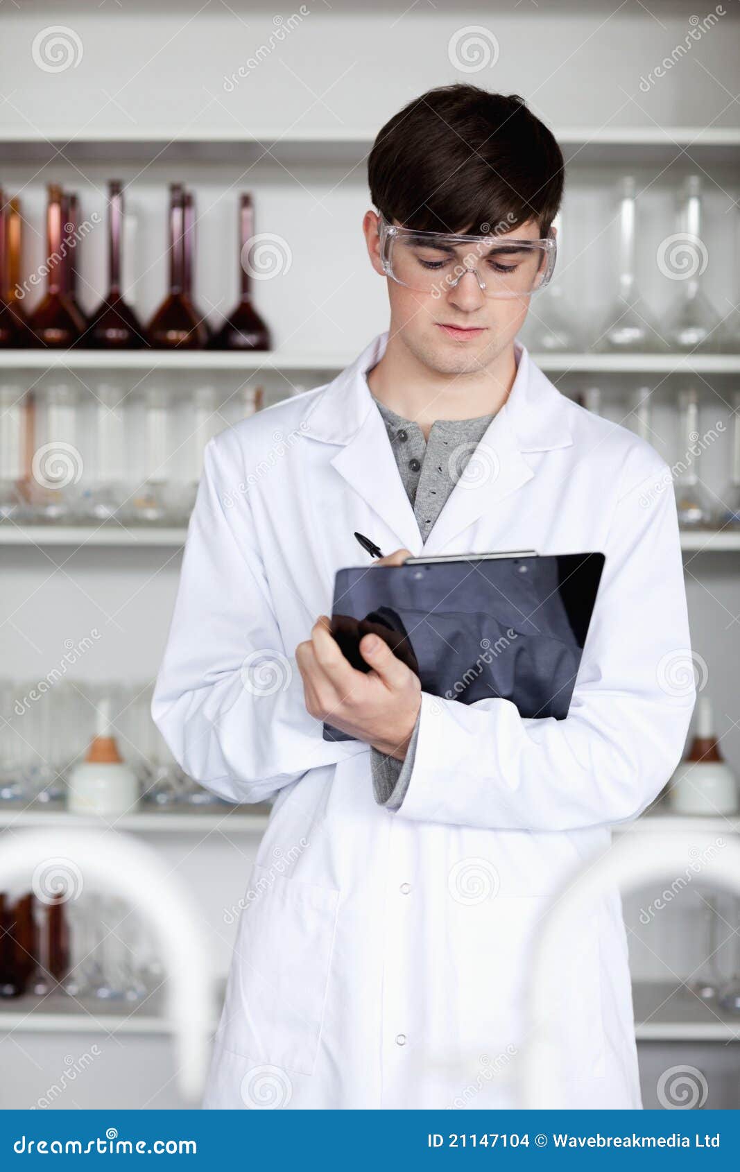 A Male Scientist Writing on a Clipboard Stock Photo - Image of happy ...
