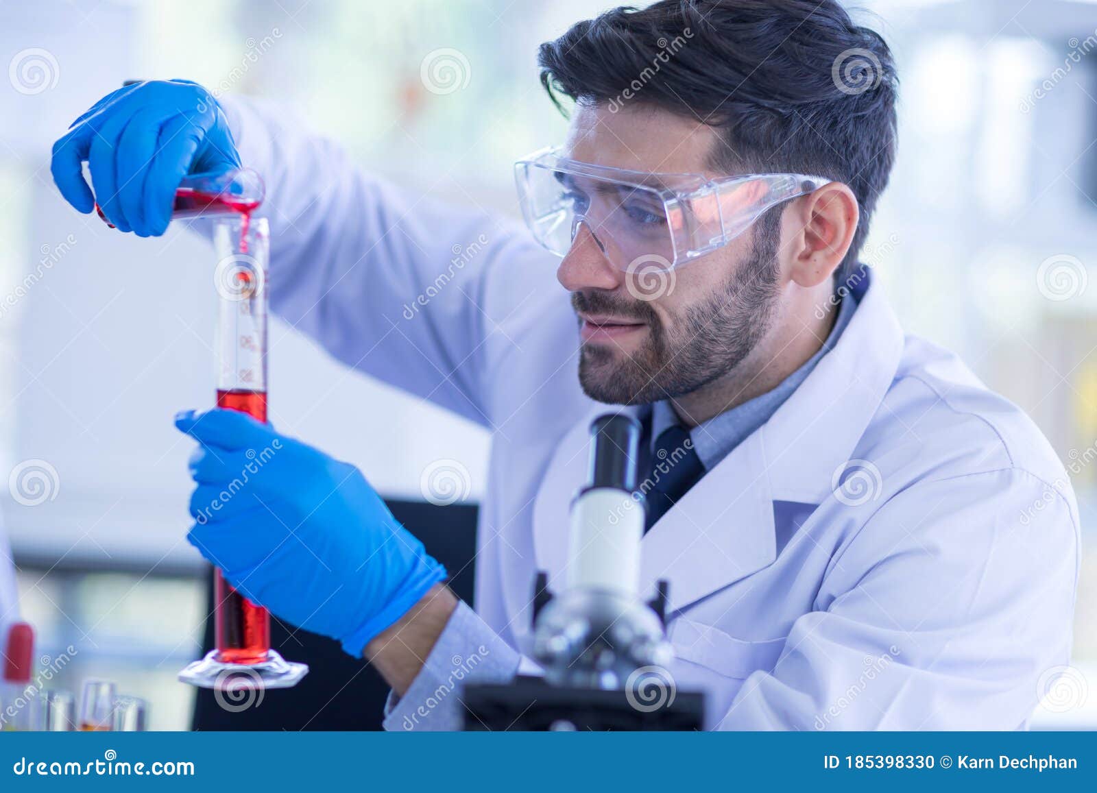 Male Scientists is Experimenting with Chemicals in the Laboratory Stock ... Male Scientists is Experimenting with Chemicals in the Laboratory Stock ...