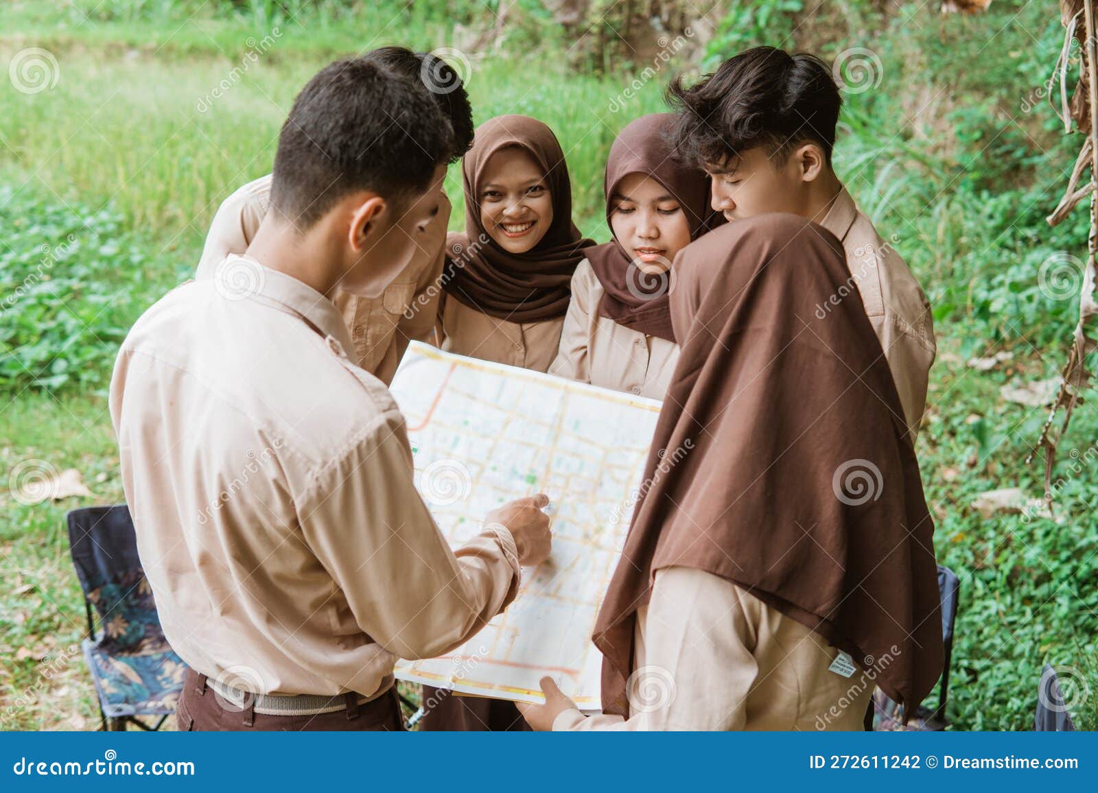 Male Scouts Hold and Point To a Location Map Stock Photo - Image of ...