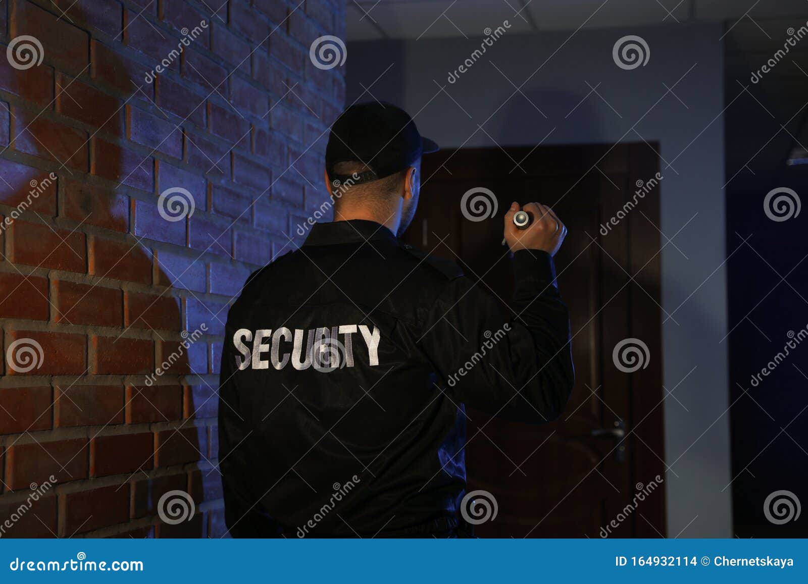 Male Security Guard with Flashlight in Corridor Stock Photo - Image of ...