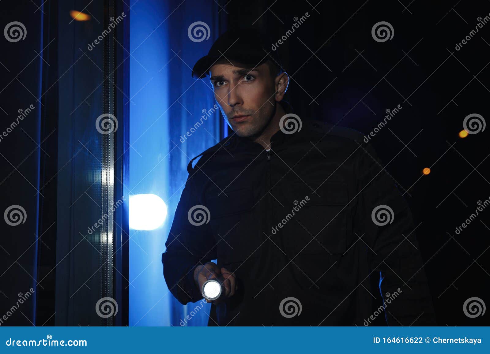 Male Security Guard with Flashlight in Corridor Stock Photo - Image of ...
