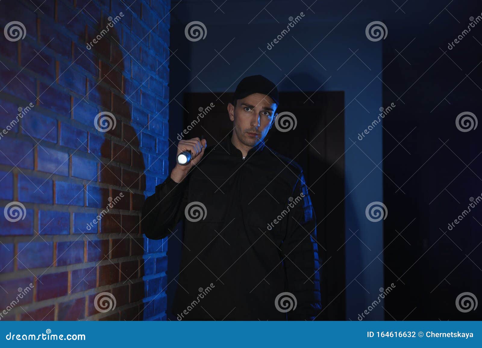 Male Security Guard with Flashlight in Corridor Stock Photo - Image of ...