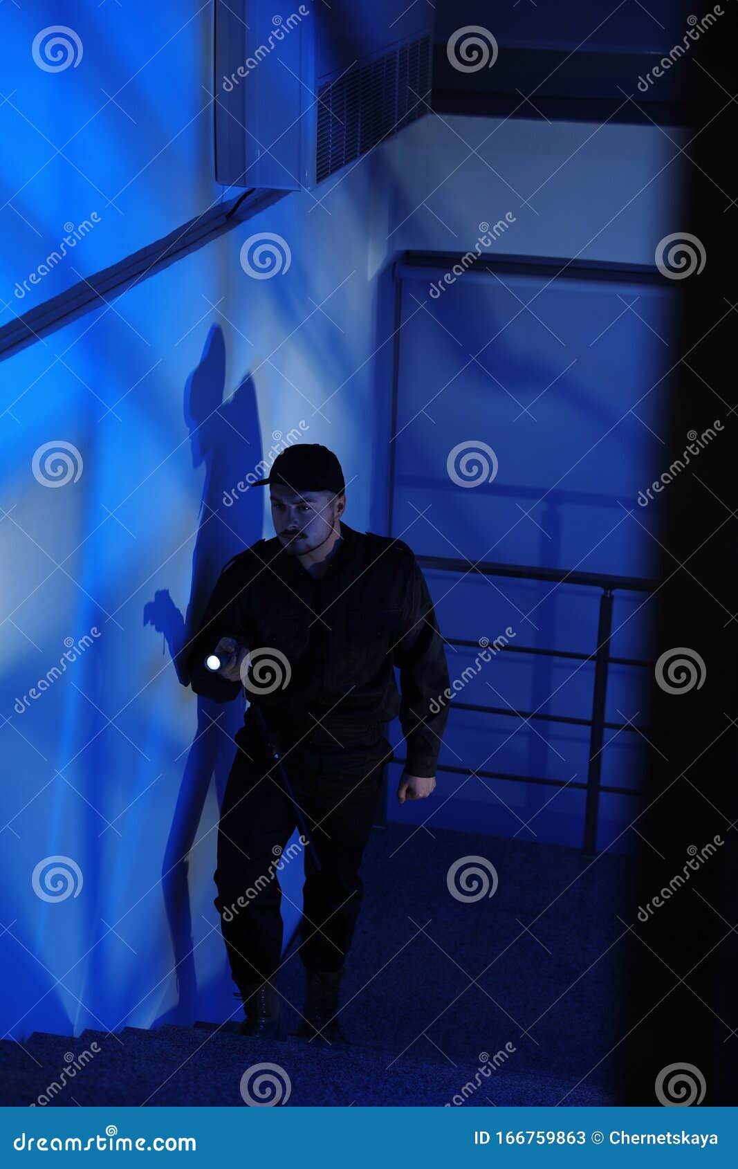 Male Security Guard with Flashlight Going Up Stairs Stock Image - Image ...
