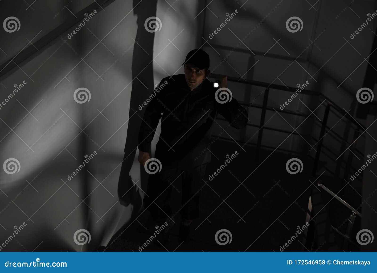 Male Security Guard with Flashlight Going Up Stairs Stock Photo - Image ...