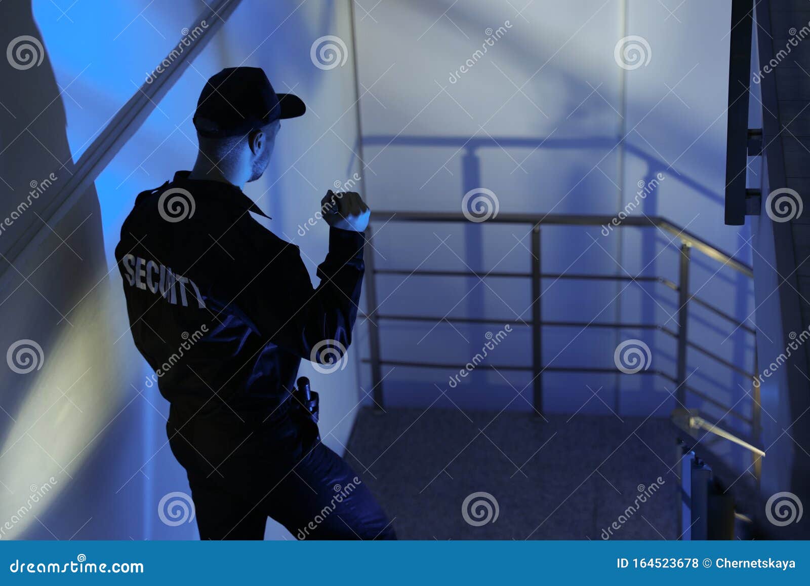 Male Security Guard with Flashlight on Stairs Stock Photo - Image of ...